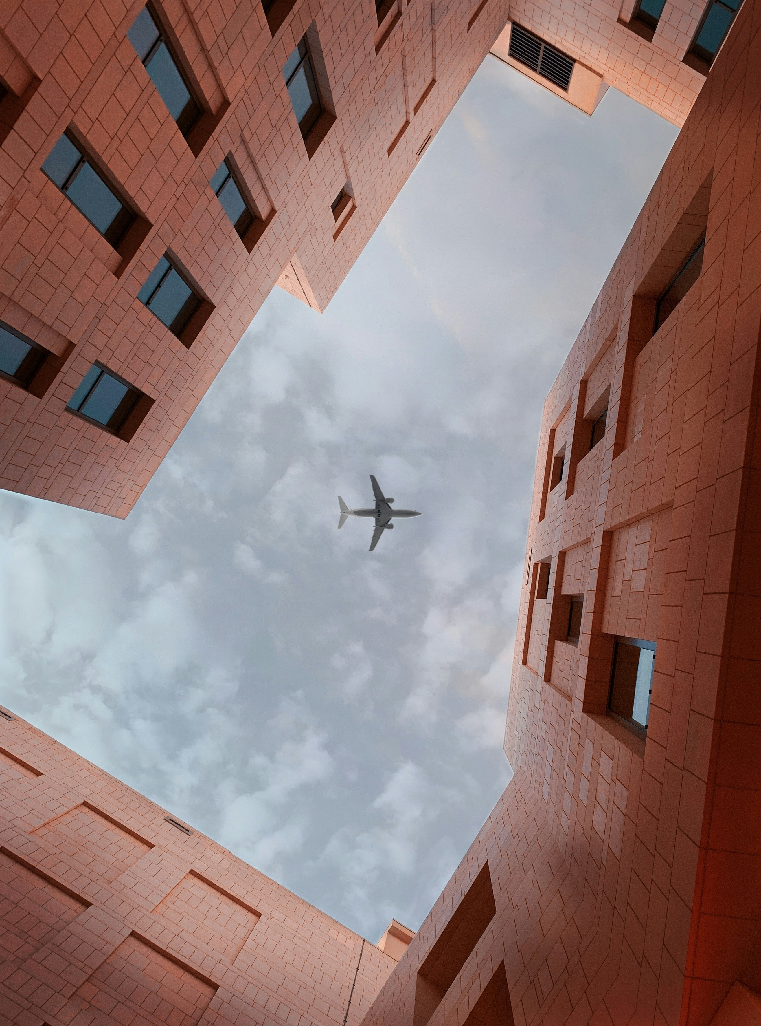 Skyward Glyph: An Aerodynamic Crossing Between Brick Towers