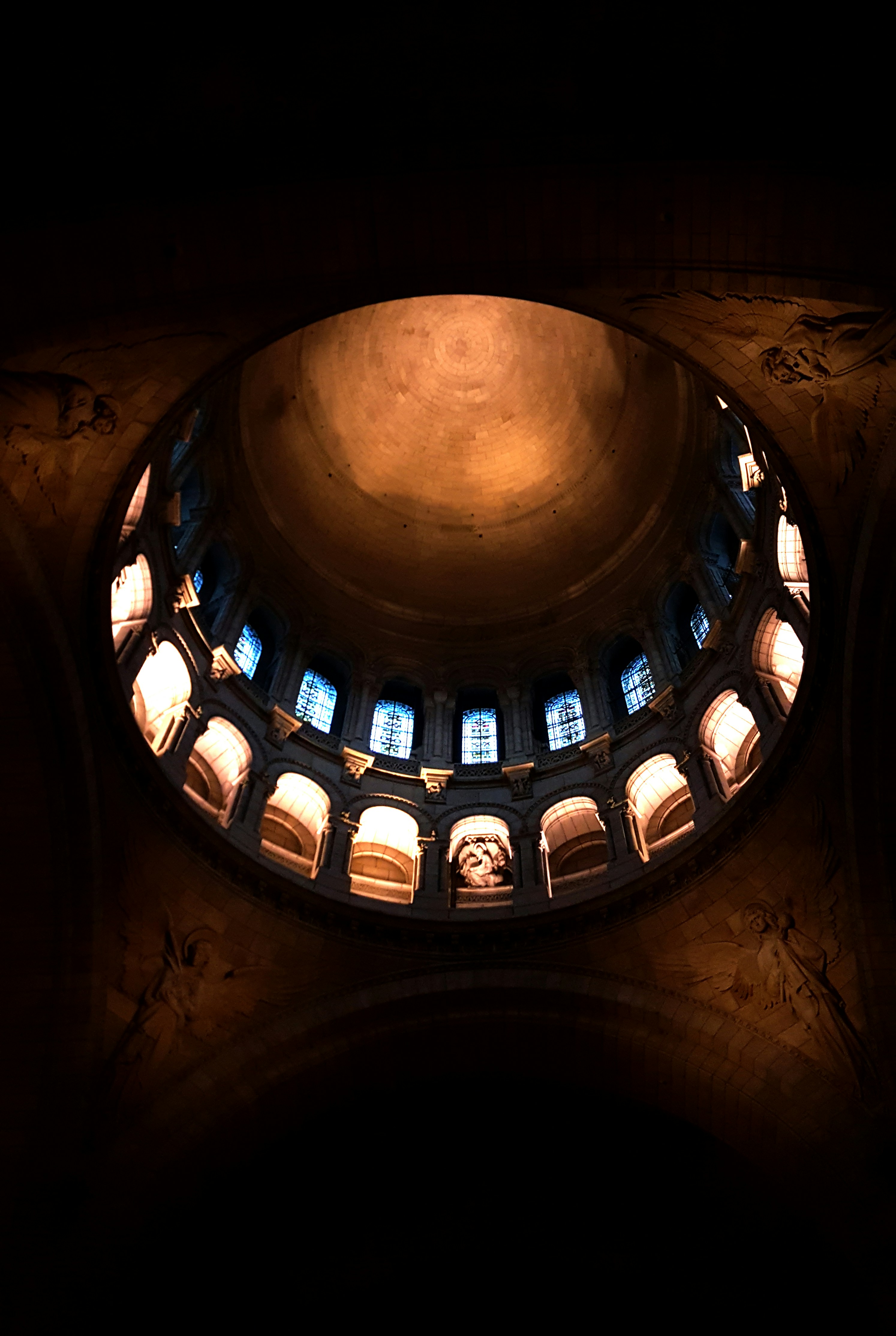 Dome interior showcasing intricate arches and illuminated windows, highlighting architectural beauty and historical significance.