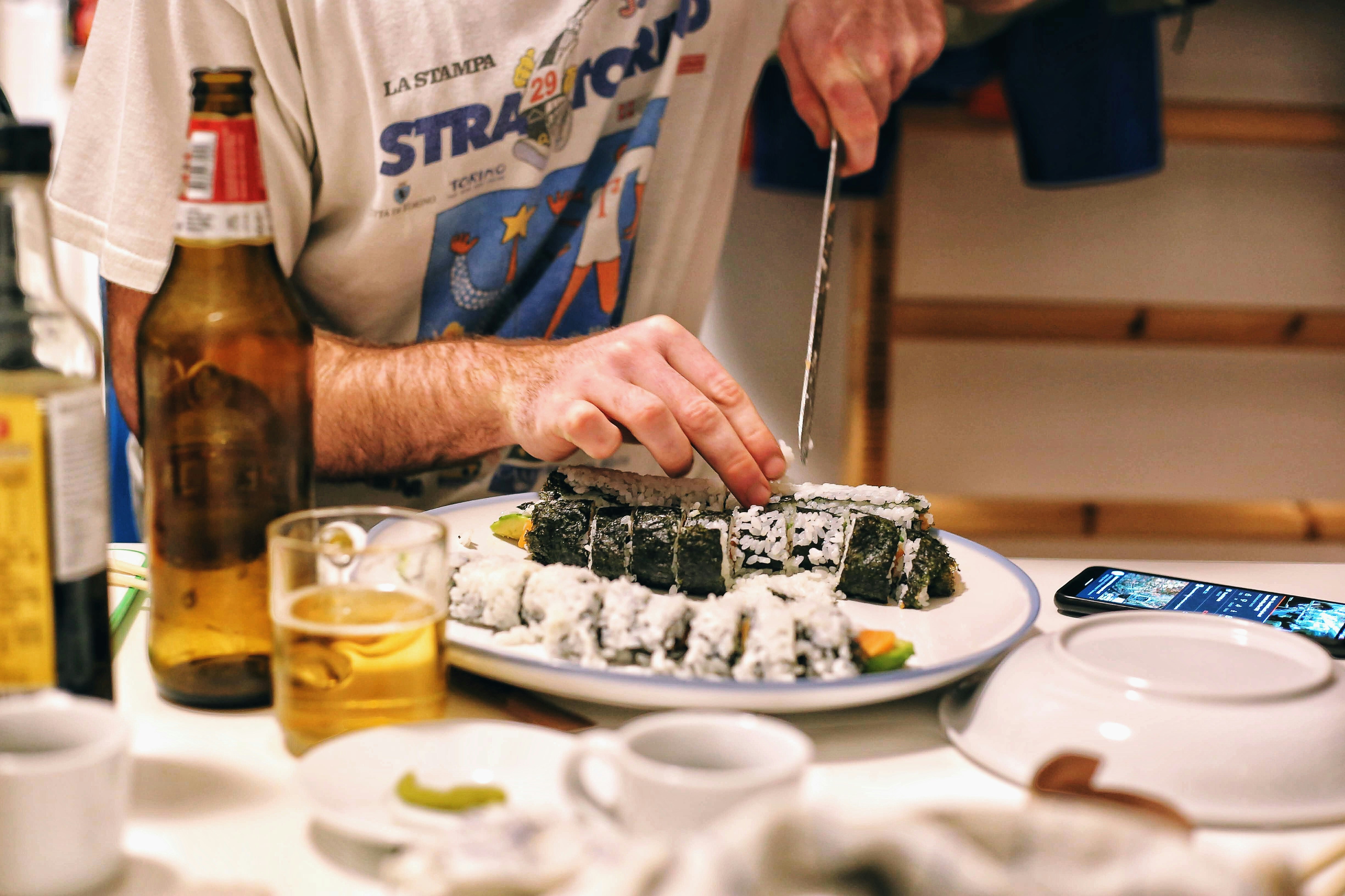 Chop, Sip, Glow: A Casual Sushi Moment Under Warm Table Light