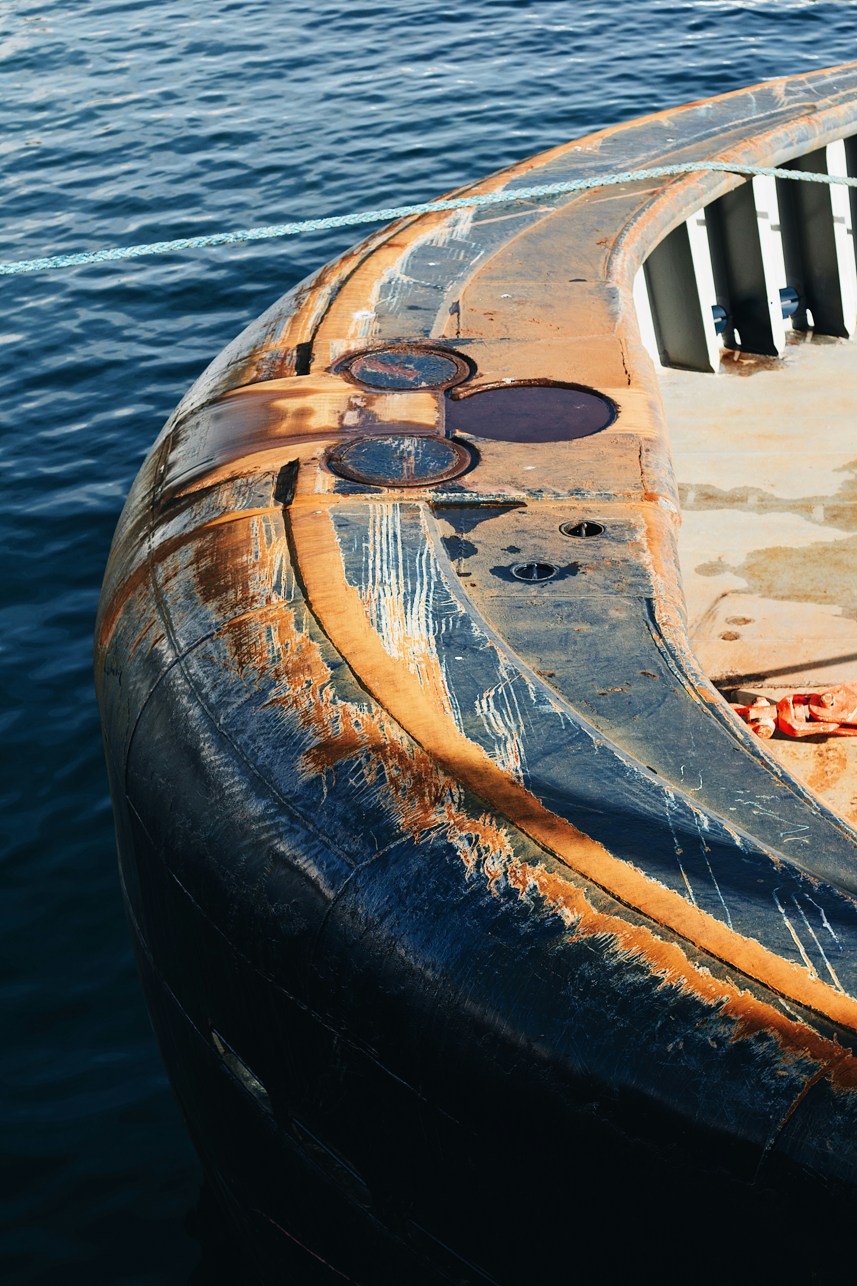 brown and blue wooden boat on water during daytime