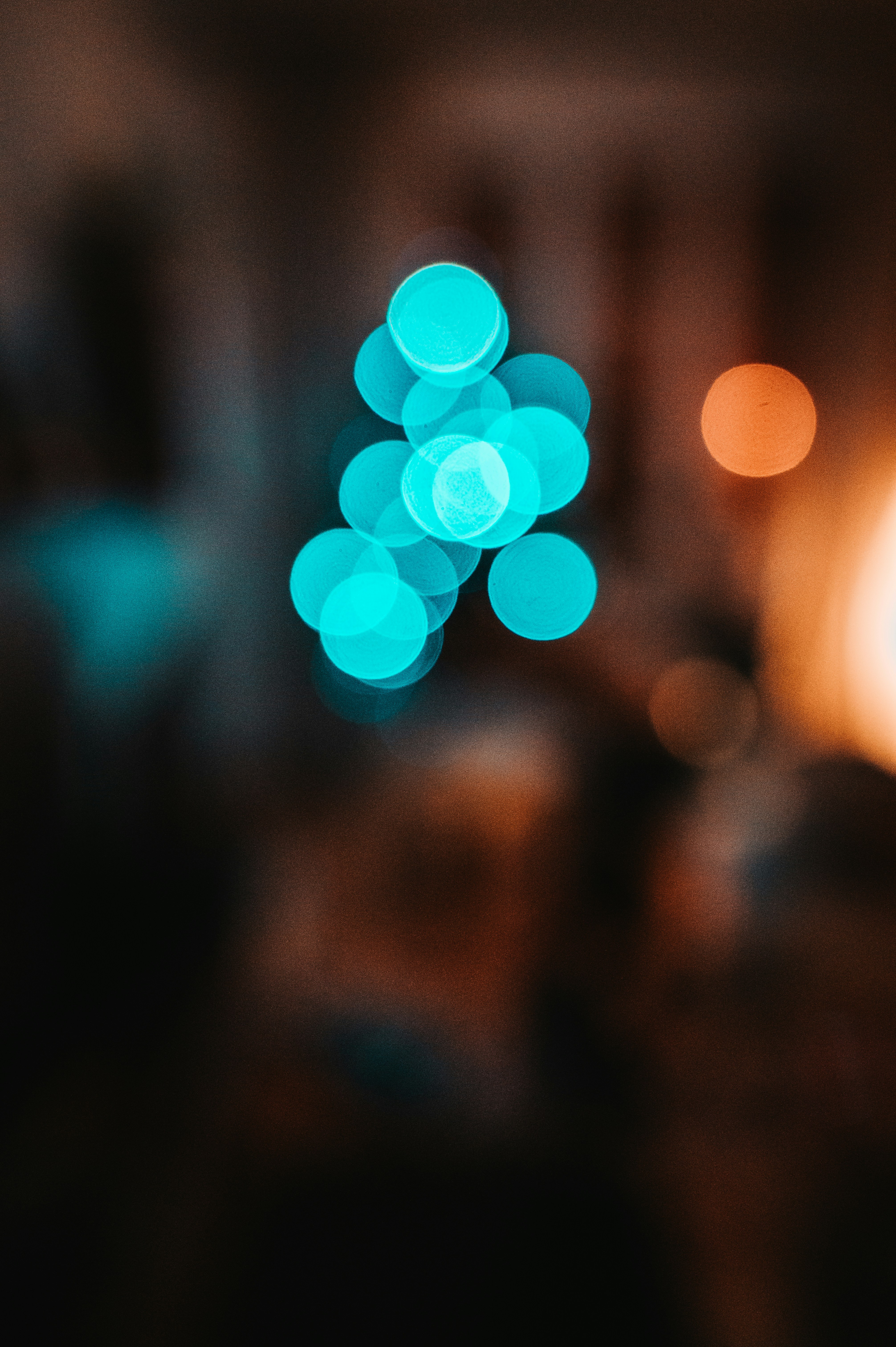 Azure Orbs Drift Through a Nocturnal City Blur