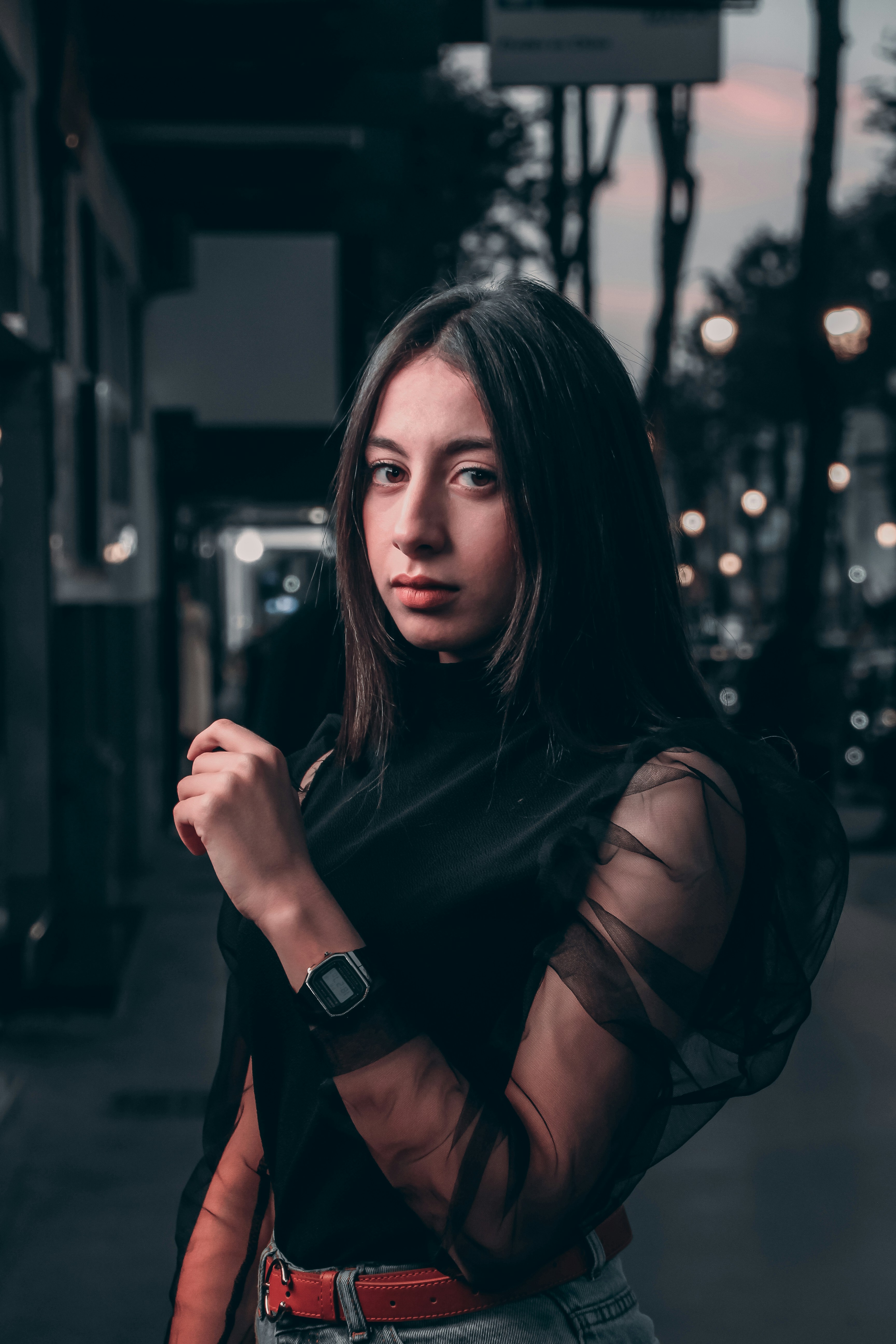 Starlit Street Portrait: Focused Gaze Under City Glow