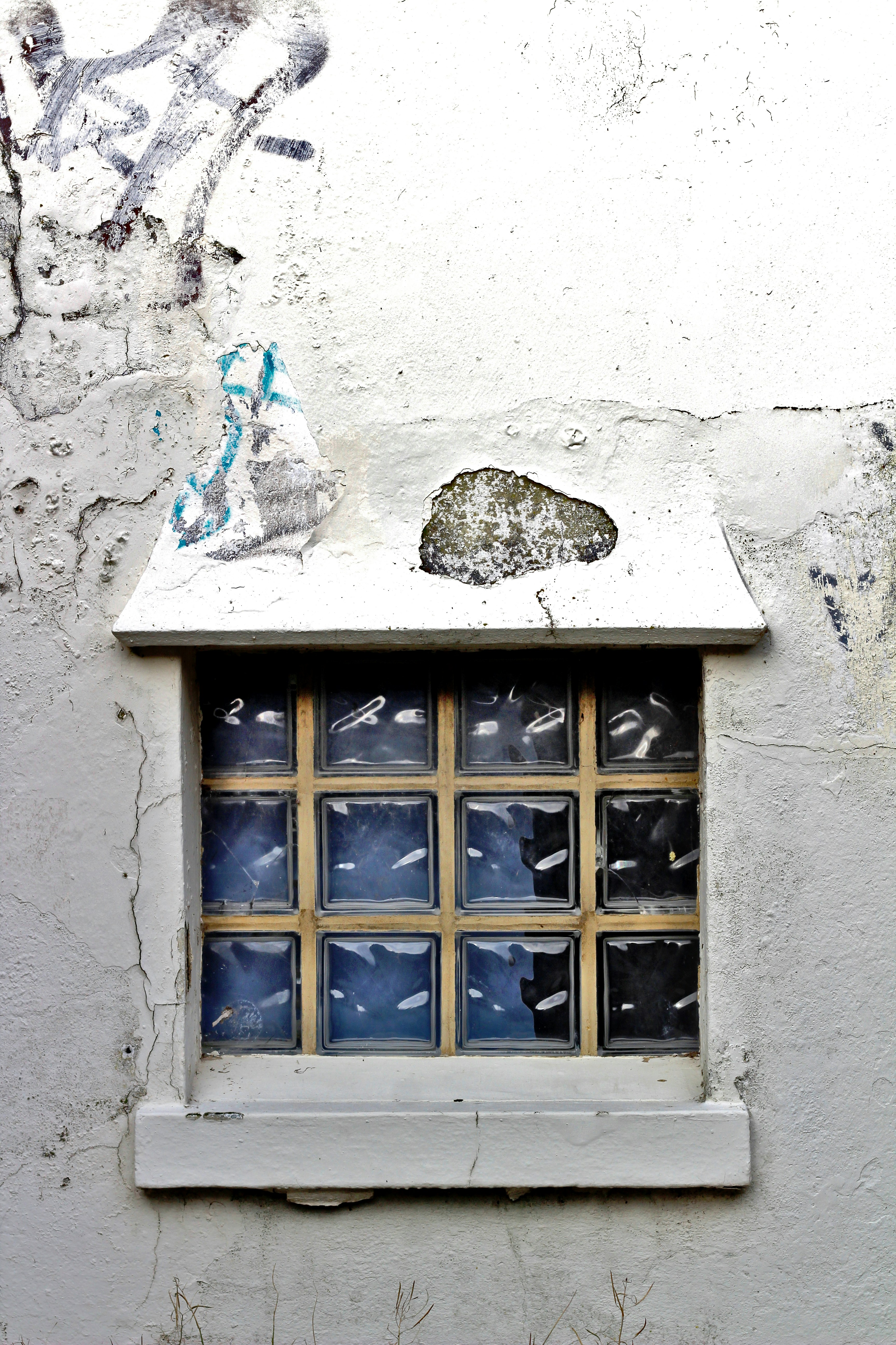 Twelve-Pane Window: Quiet Light in a Crumbling Facade