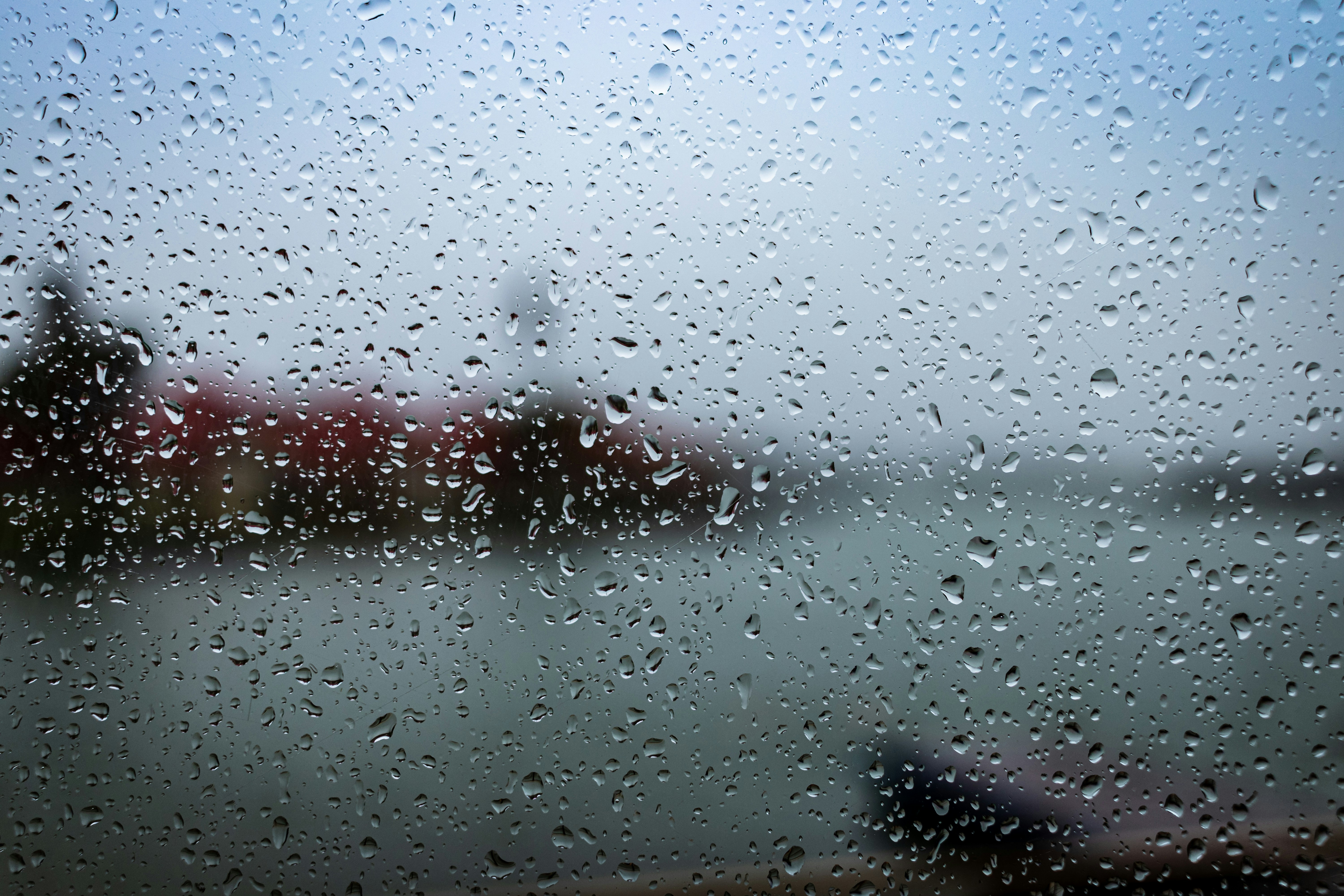 Rain-Streaked Window Over a Distant Harbor