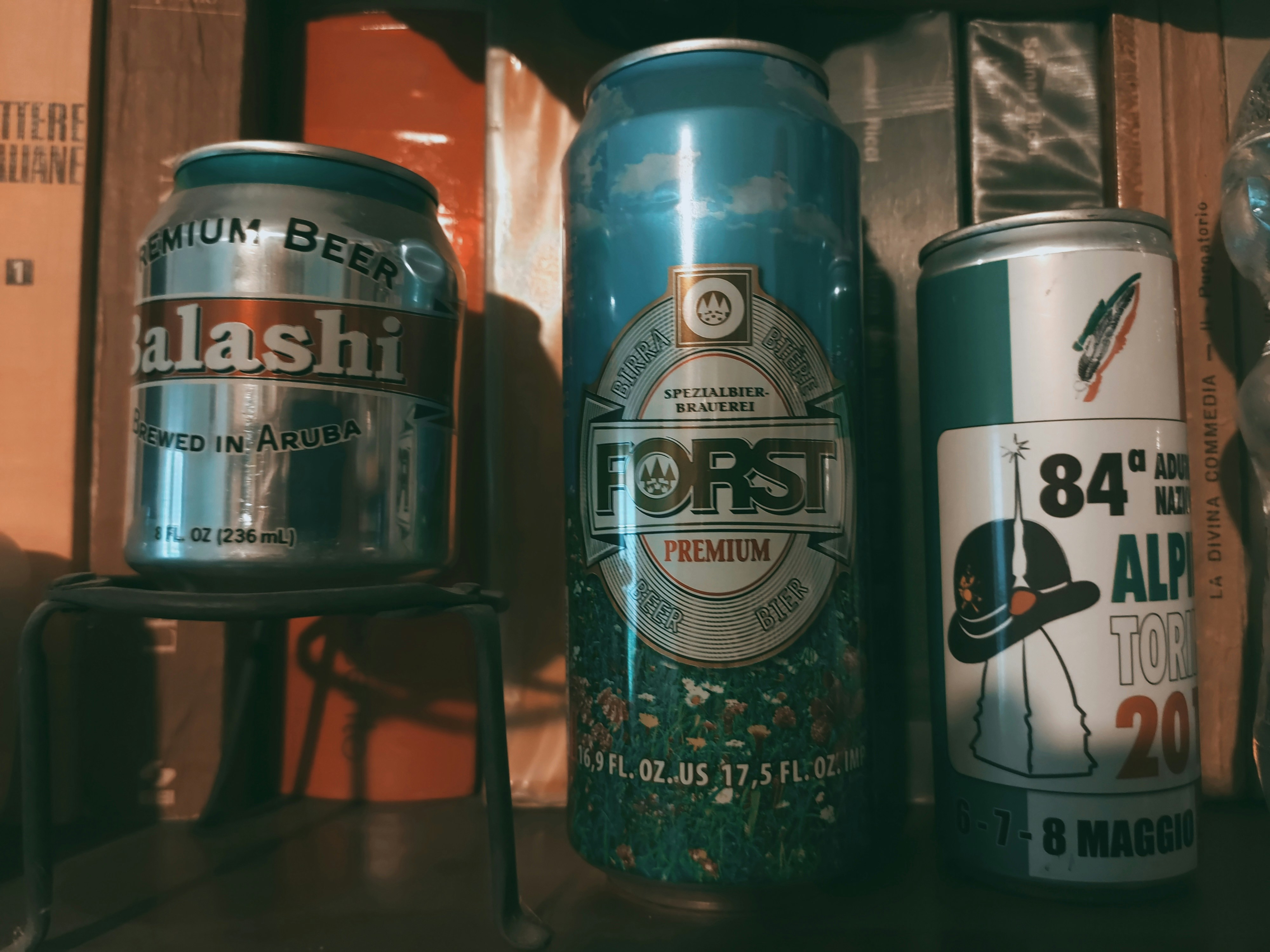 Three Aluminum Menagerie: Cold Cans on a Dark Shelf
