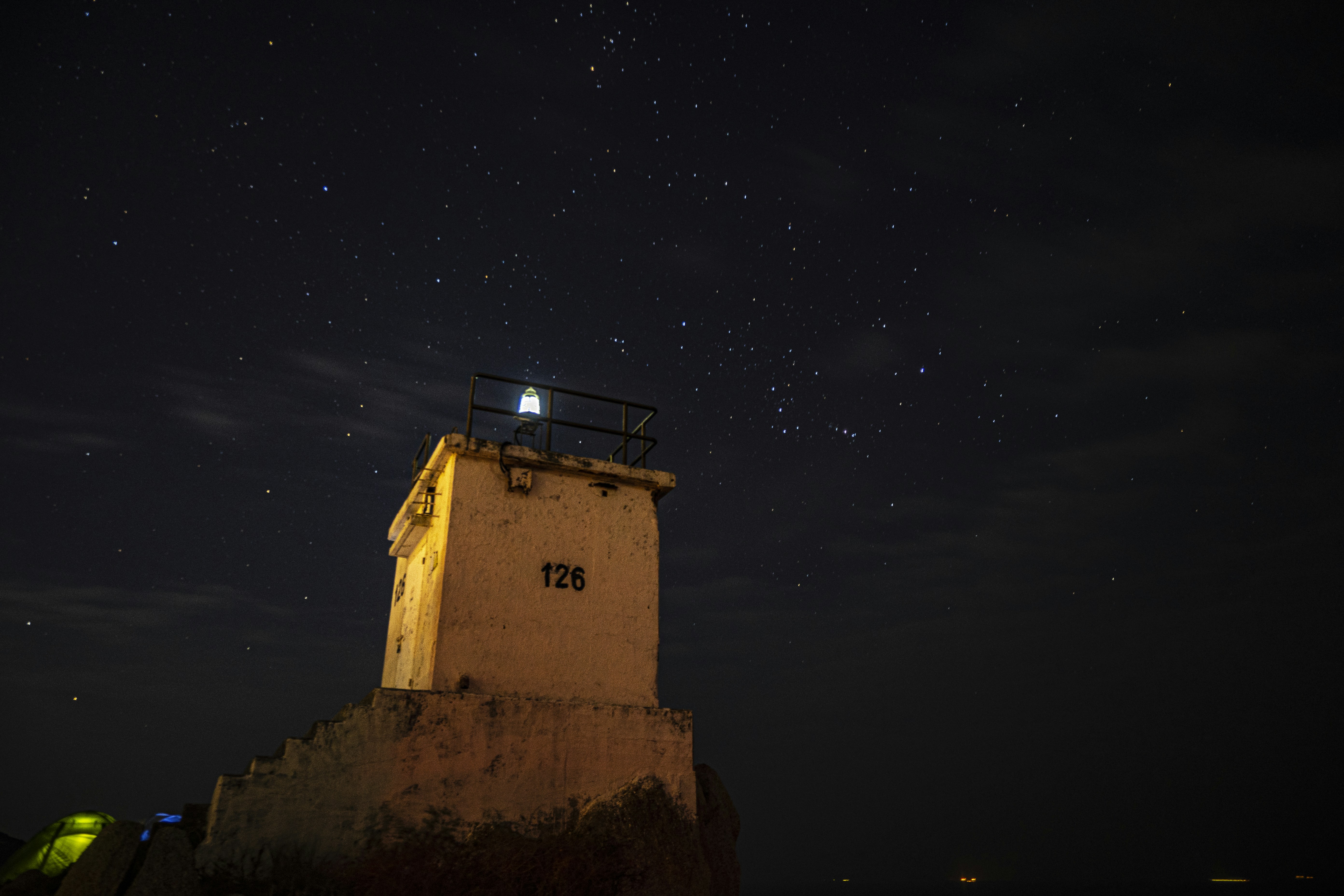 Lighthouse in Starlight: Sentinel on the Ridge
