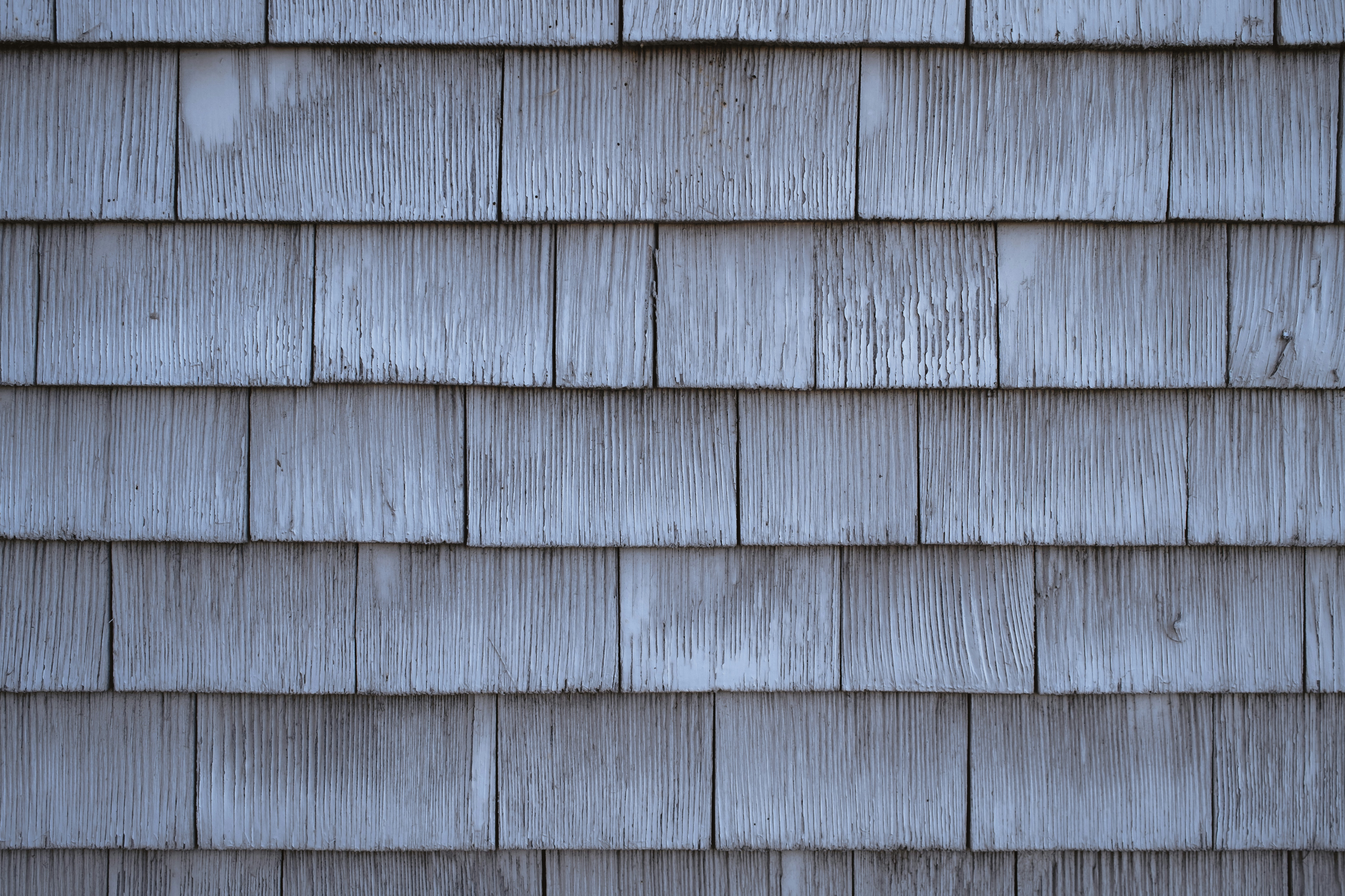 Close-up of weathered wooden shingles, showcasing their texture and aging process.