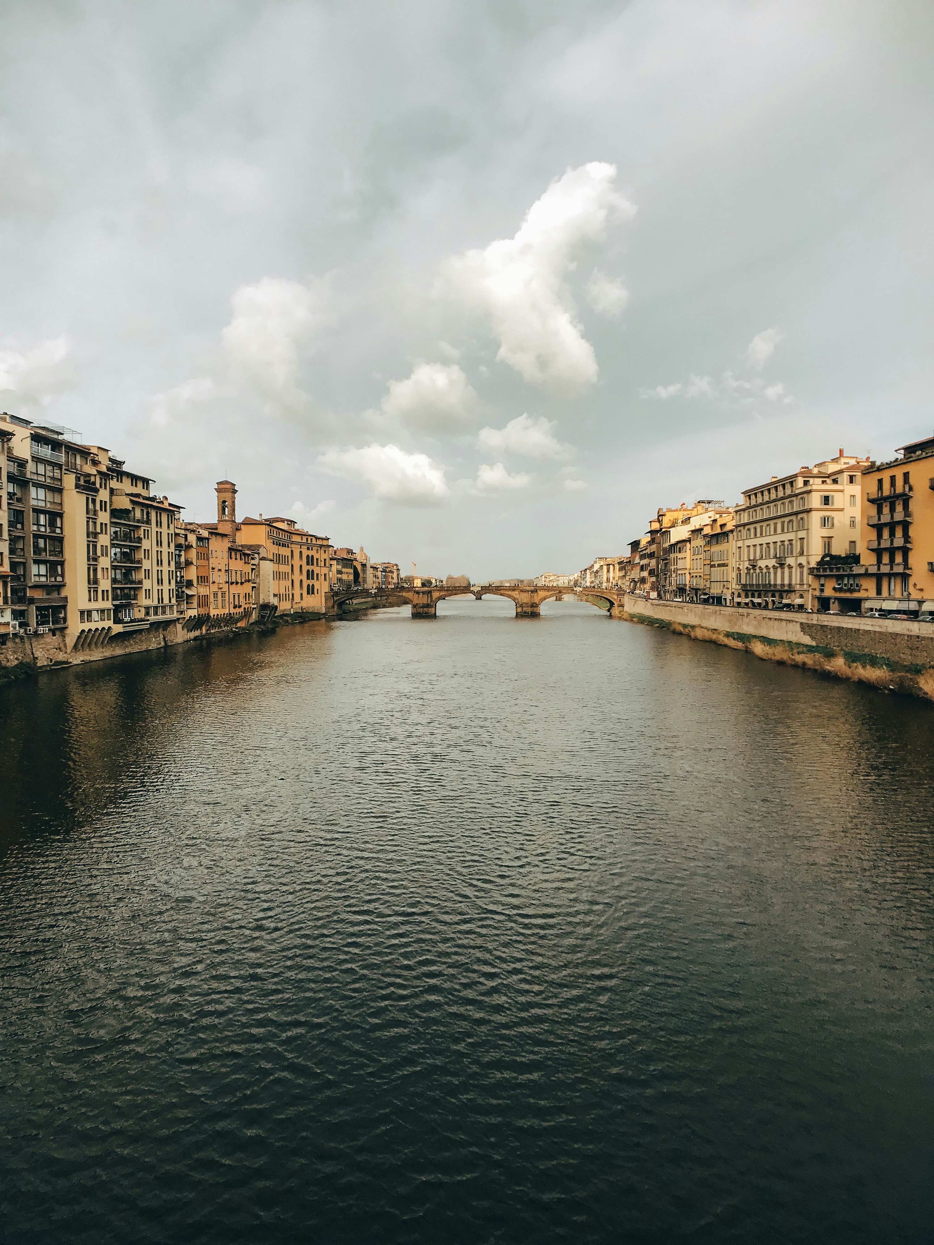 River between buildings under white clouds and blue sky during daytime ...
