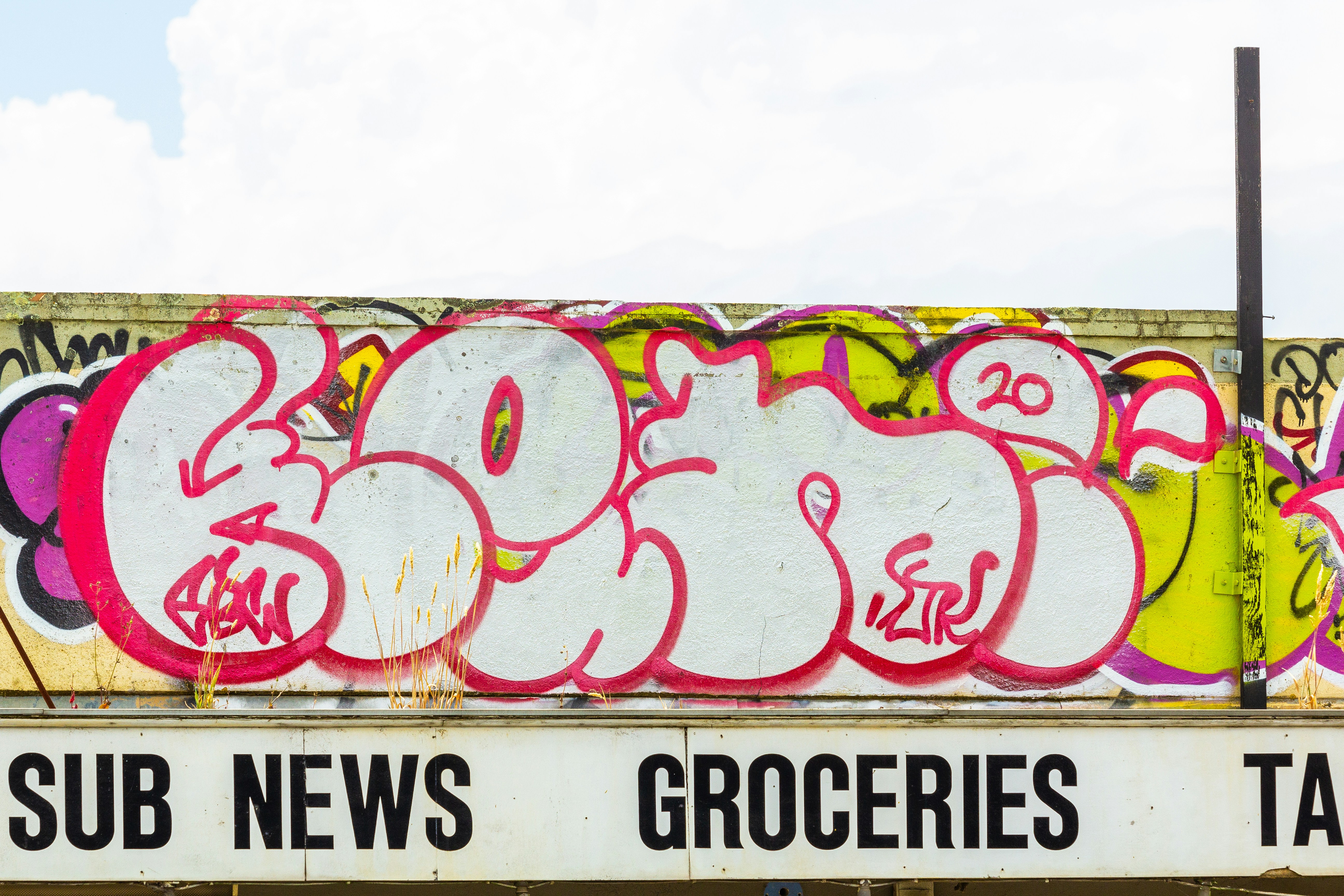 Graffiti Script Over a Diner-Ligned Wall