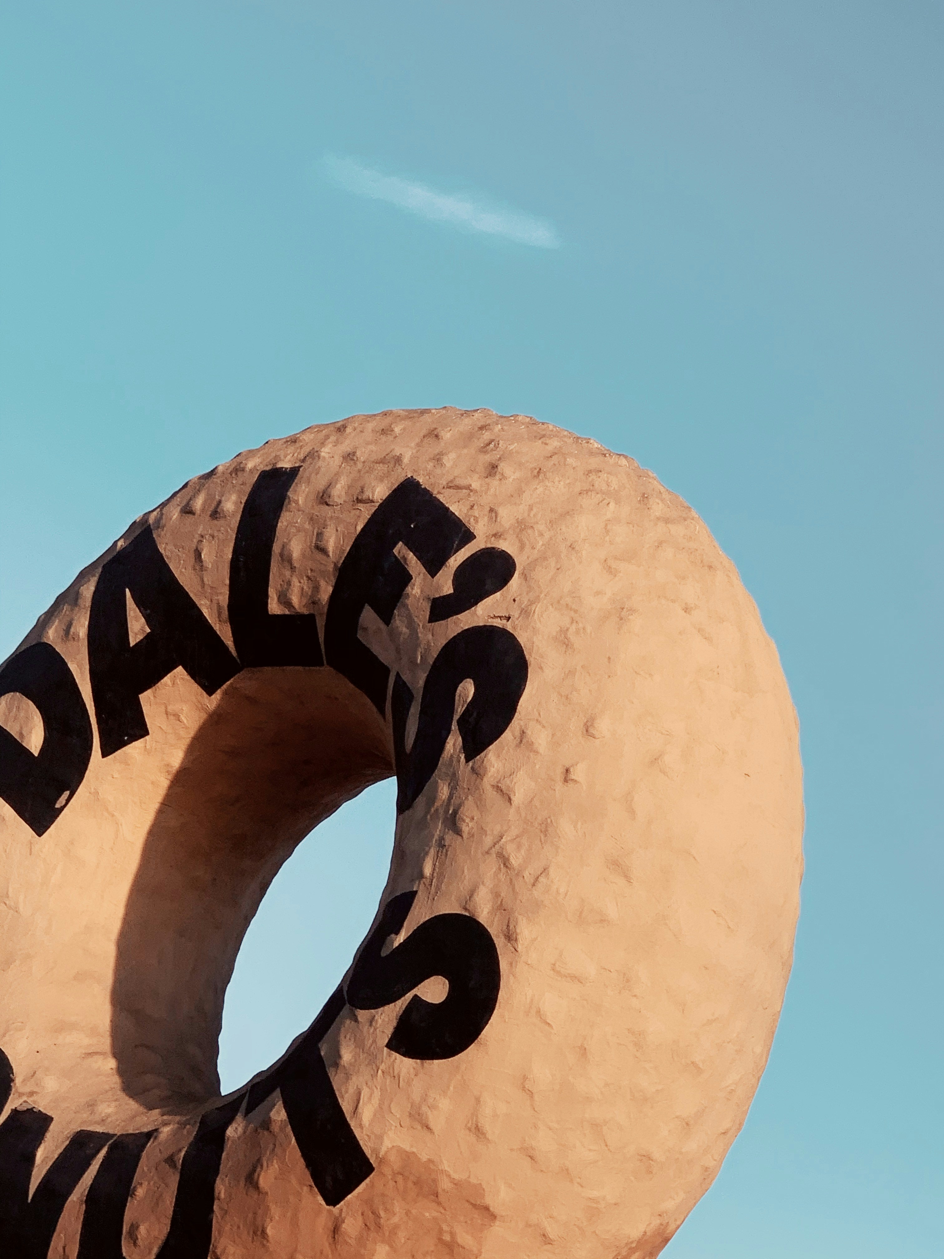 Curved Olive Ring: A Bold Perspective Against a Clear Sky