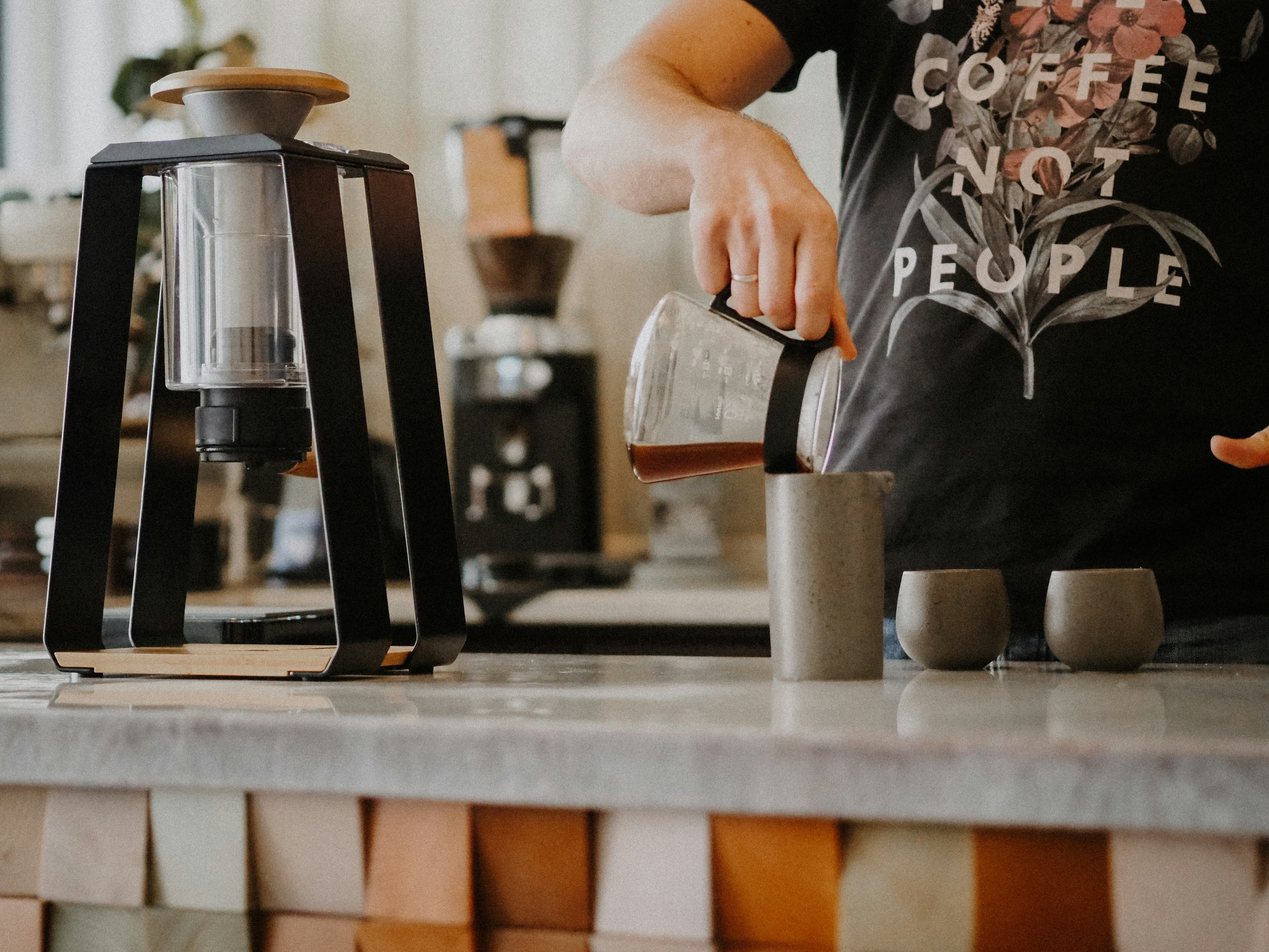 Bloom Coffee Room in Lisbon. Brewing coffee on Trinity ONE brewing appliance 🖤 | person pouring coffee on coffee cup