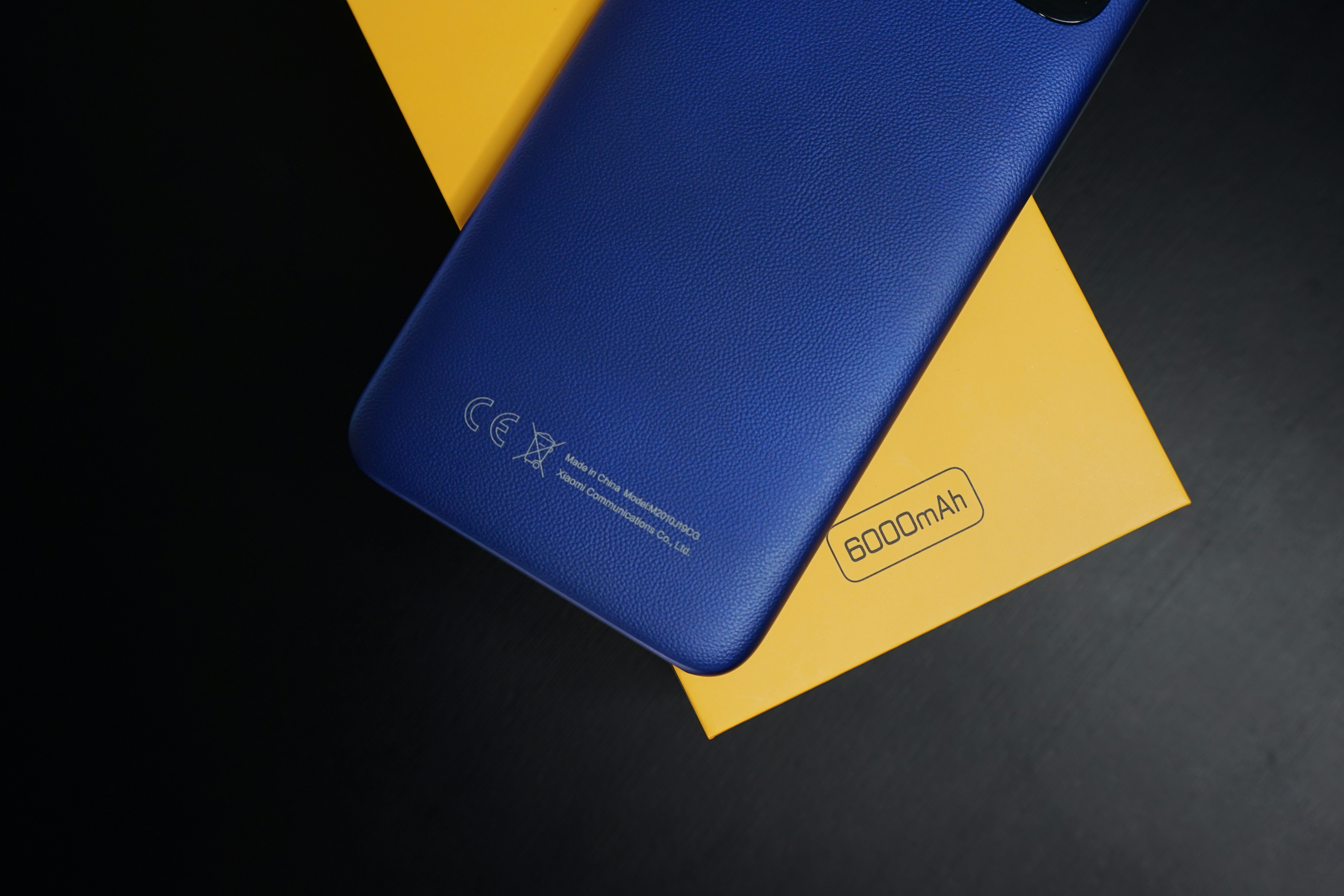 Vibrant Contrast: Blue Device on Golden Backdrop
