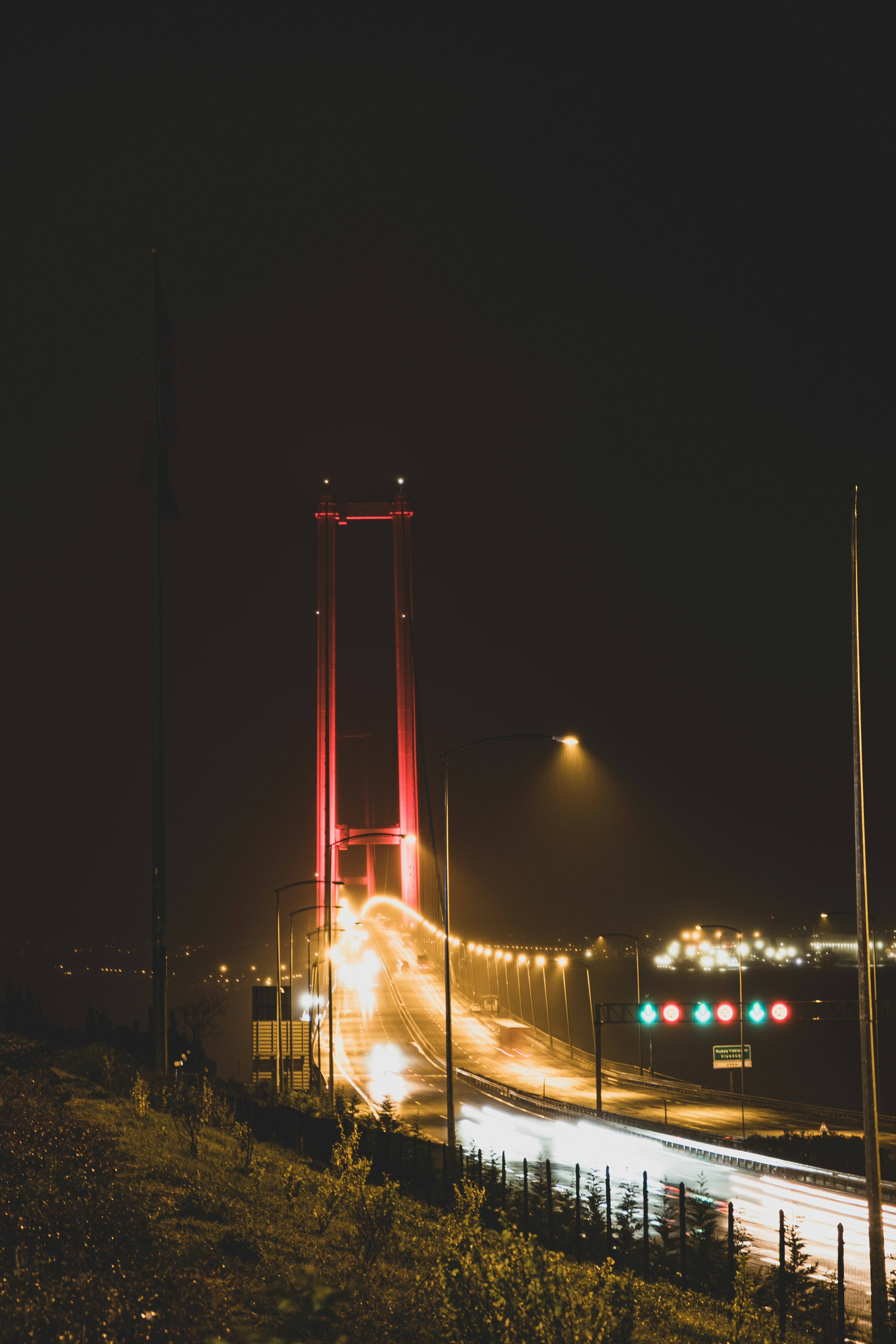 Crimson Tower Over Night Bridge: Long-Exposure Light Trails