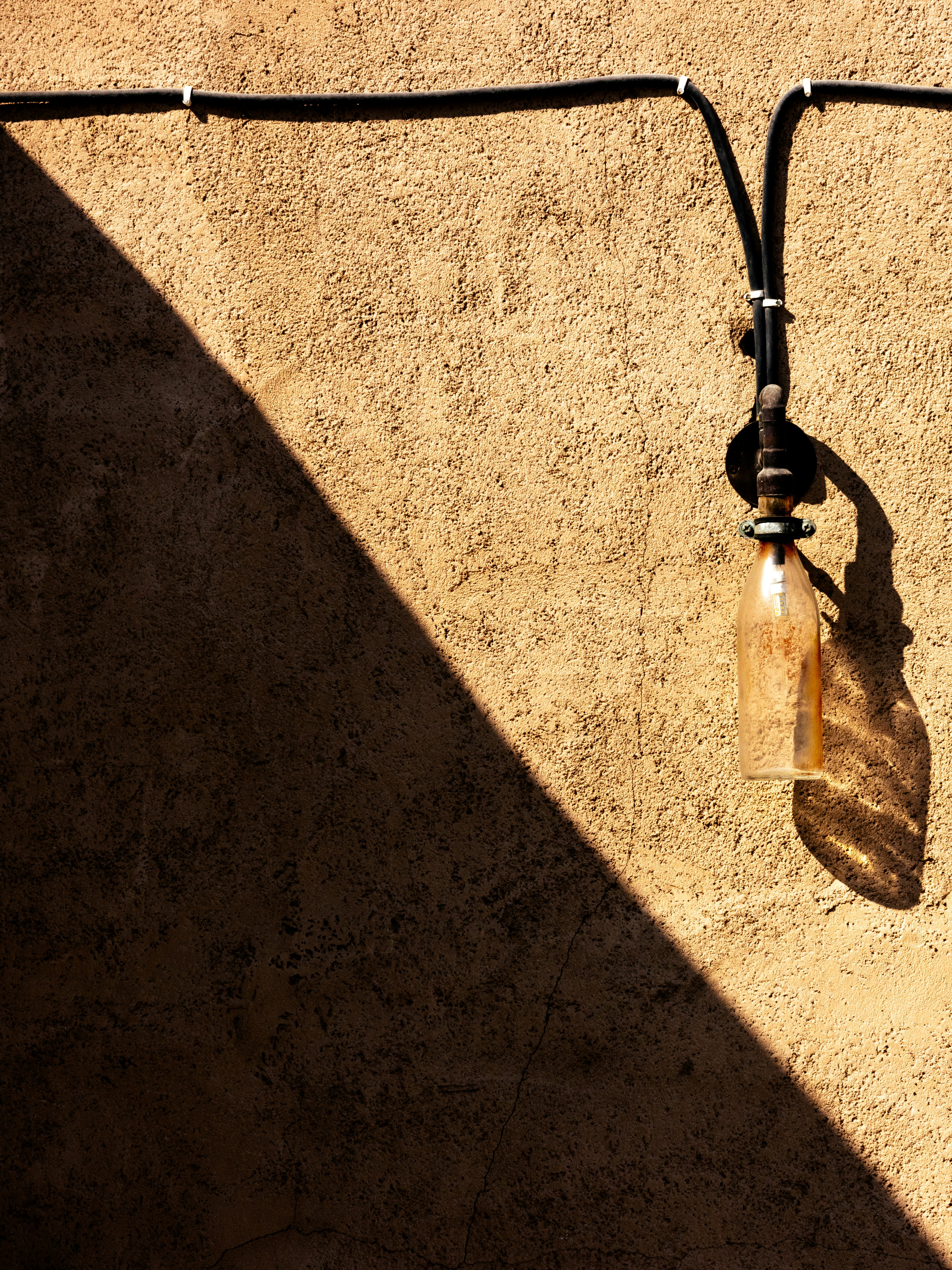 clear glass bottle on brown textile