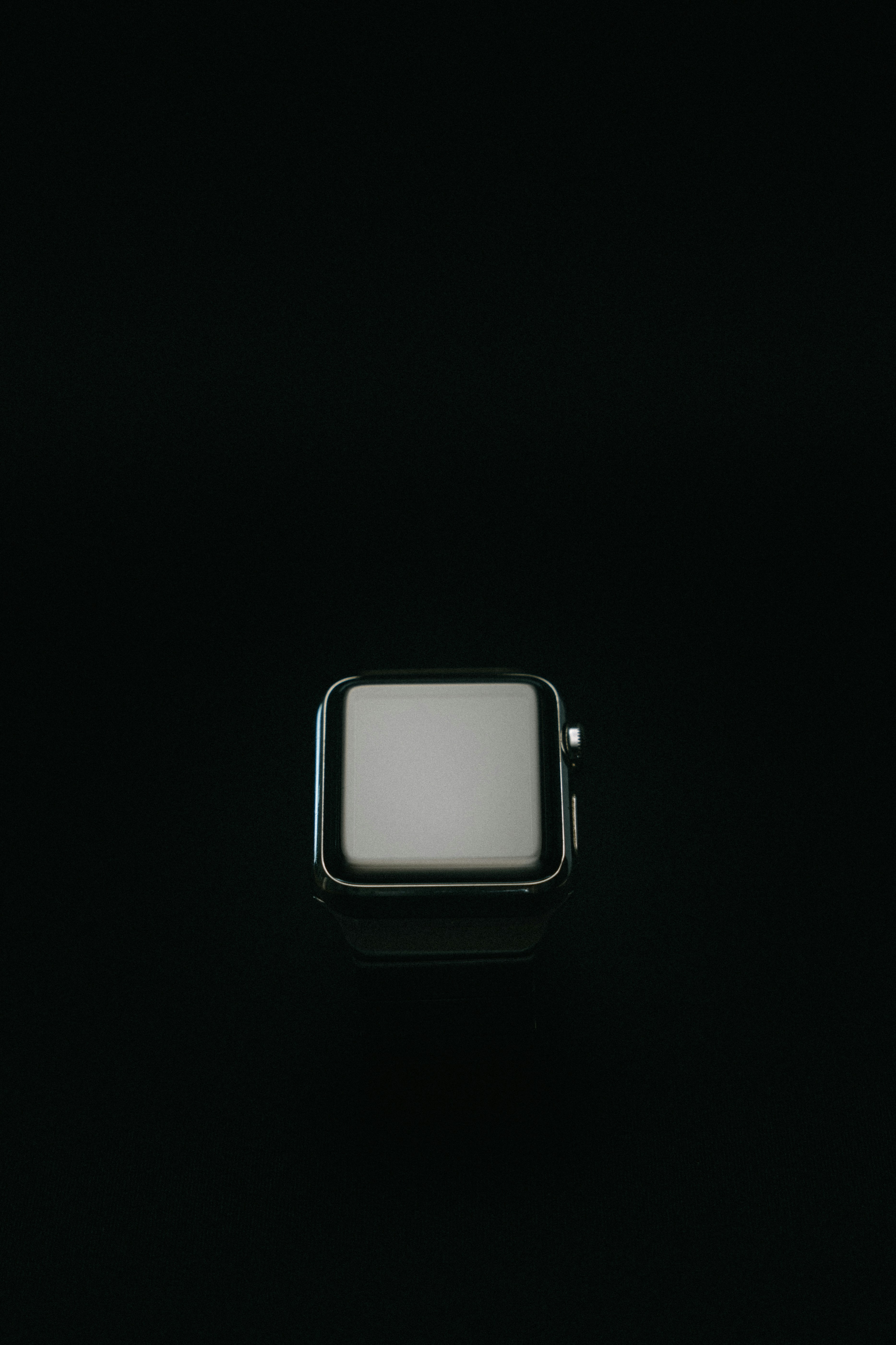 A sleek, modern smartwatch displayed against a stark black background, emphasizing its elegant design and functionality.