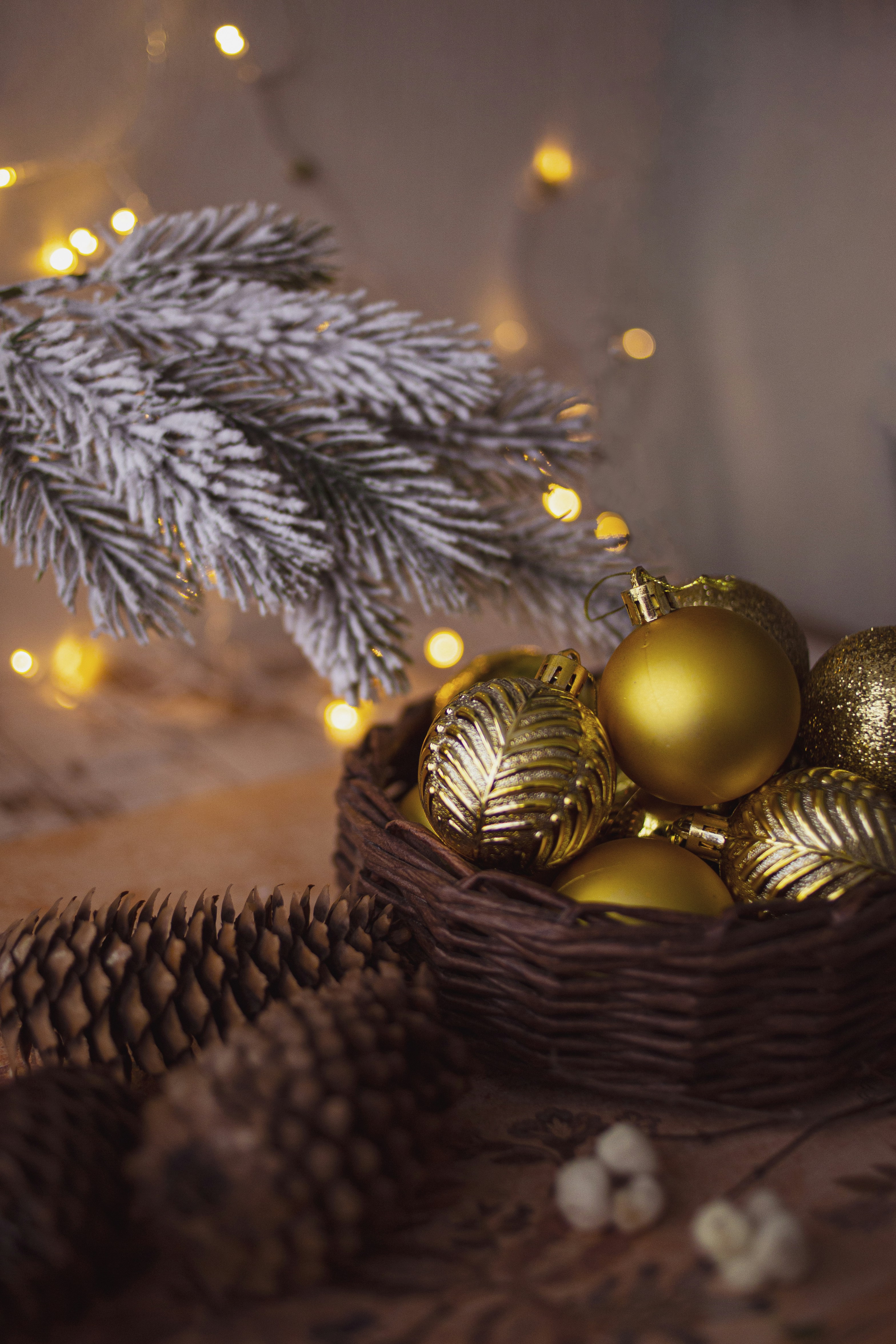 Winter Gilt: Frosted Fir, Pinecones, and Golden Ornaments in a Wicker Basket