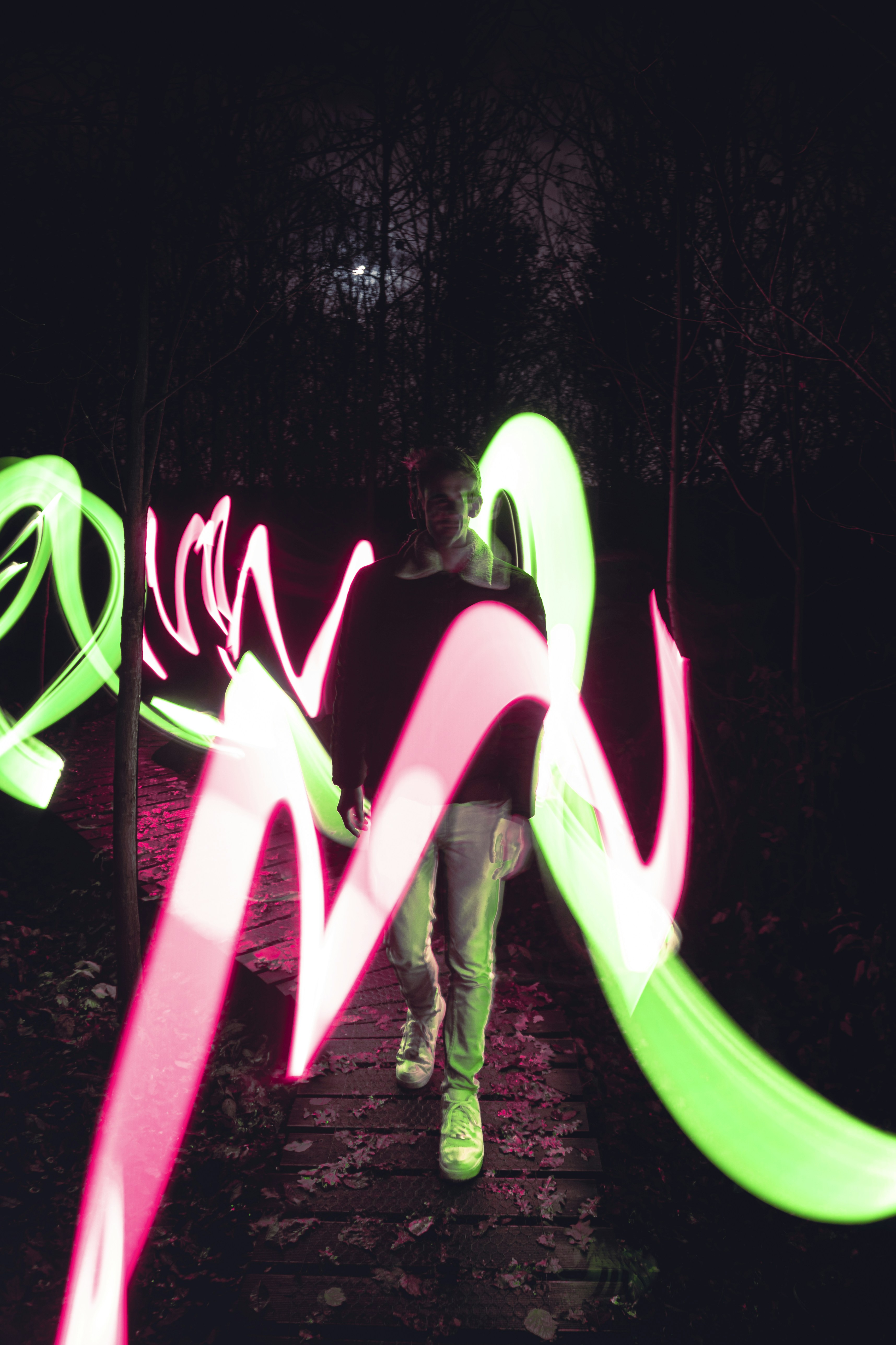 Night Light Dancer: Neon Trails Fold Around a Silhouetted Figure