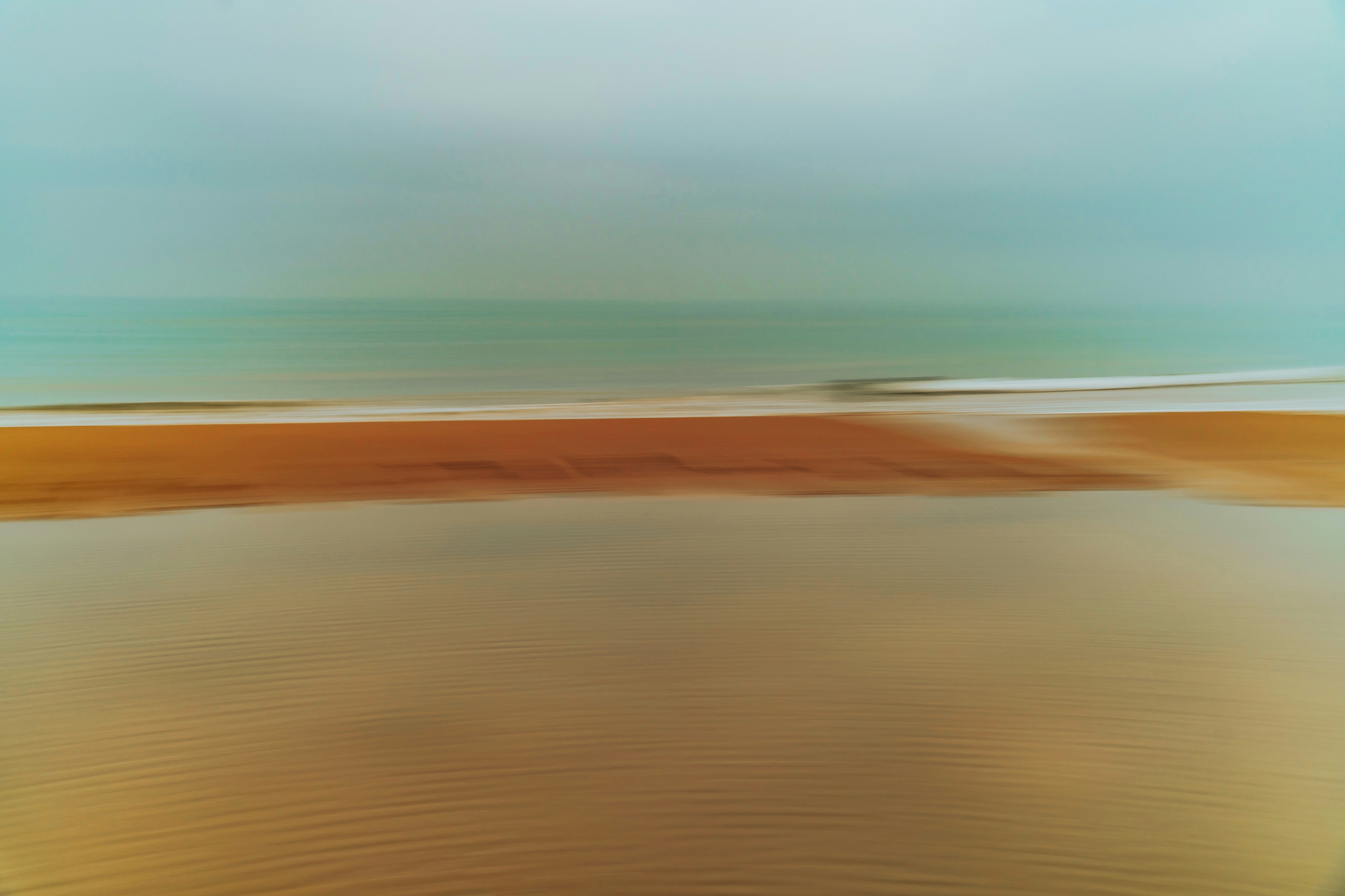 Horizon in Velvet: A Long-Exposure Seascape of Sand, Water, and Sky