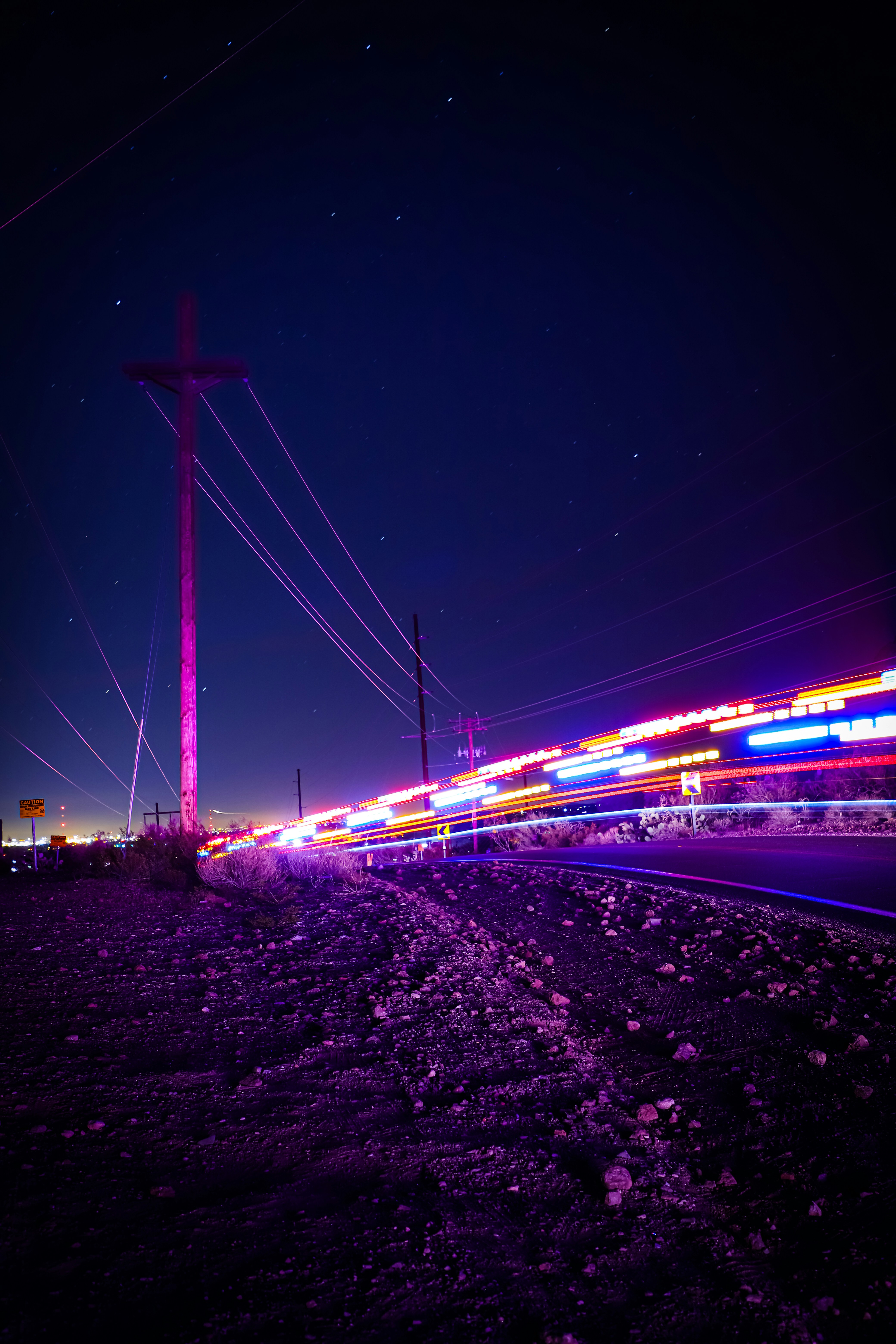 Neon Trails by the Lone Pole Under a Velvet Night Sky