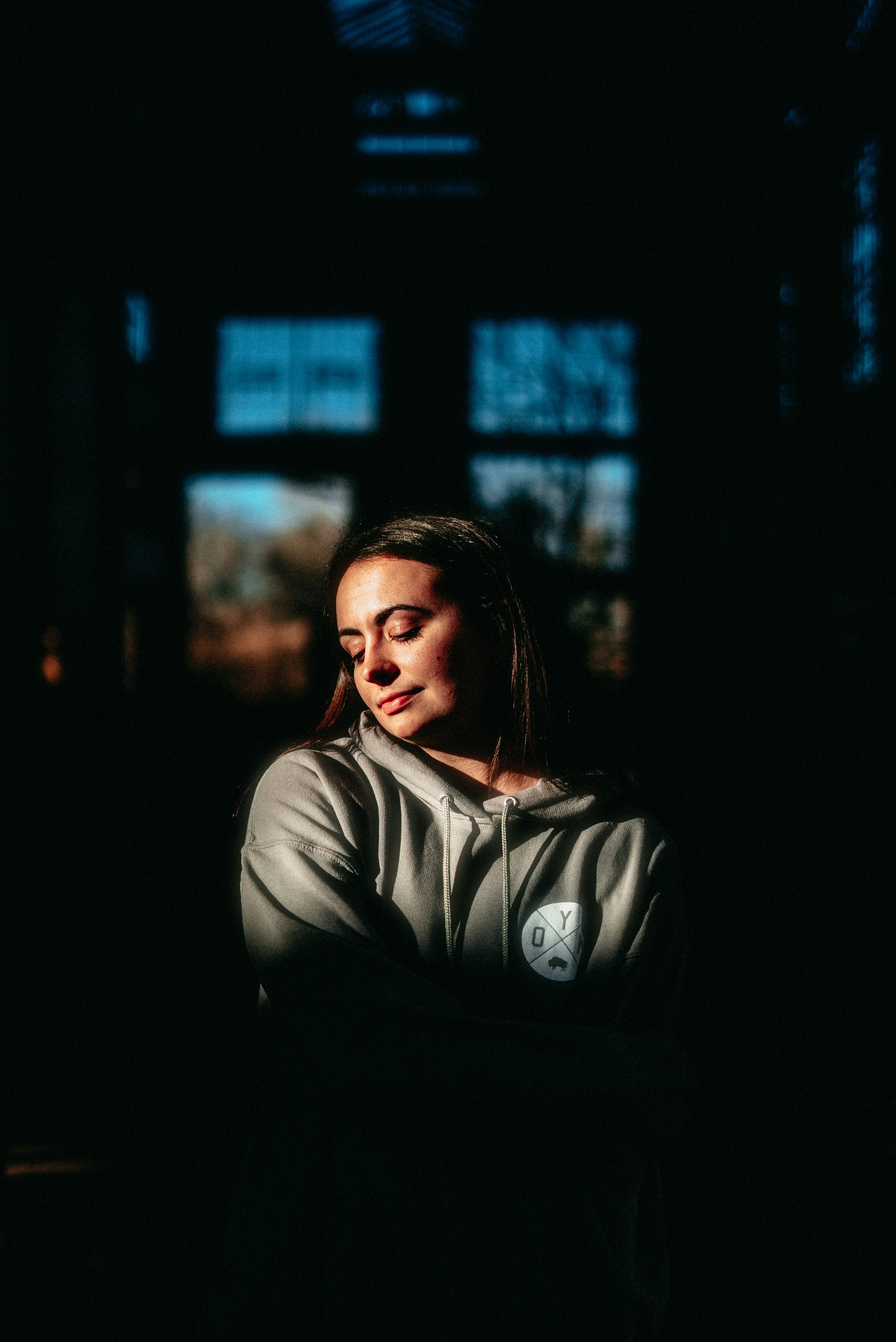 Windowed Glow: A Quiet Portrait in a Shadowed Studio