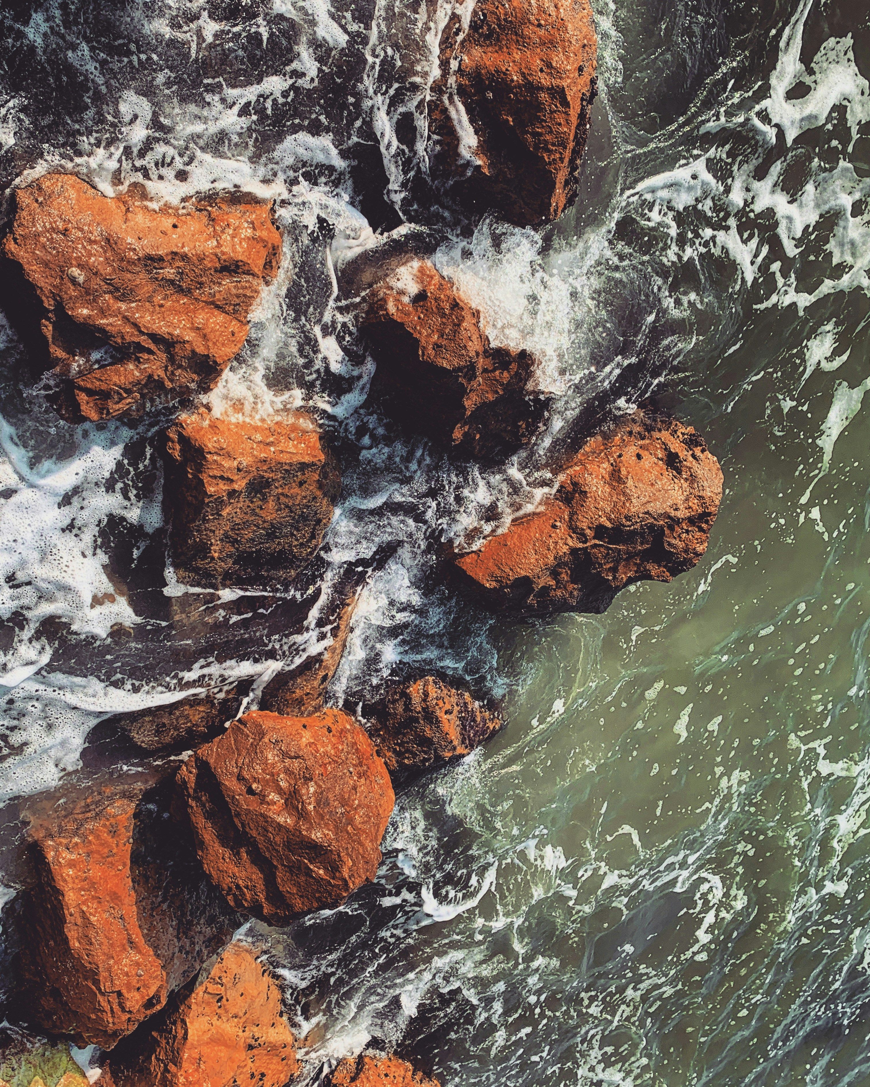Coastal Ember: Red Rocks Meet Rolling Foam