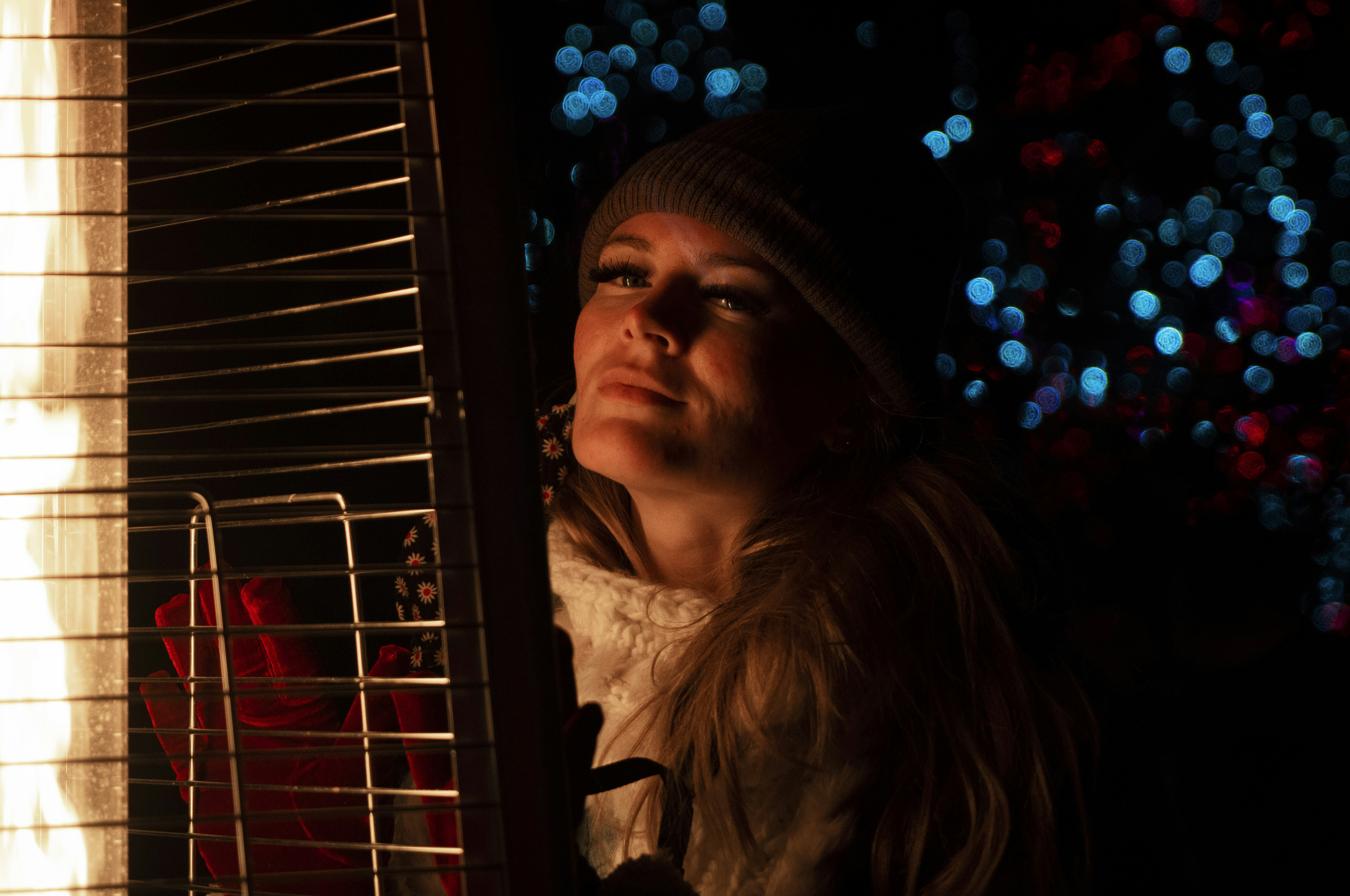 Warm Glow: A Woman Gathers Light by the Outdoor Heater