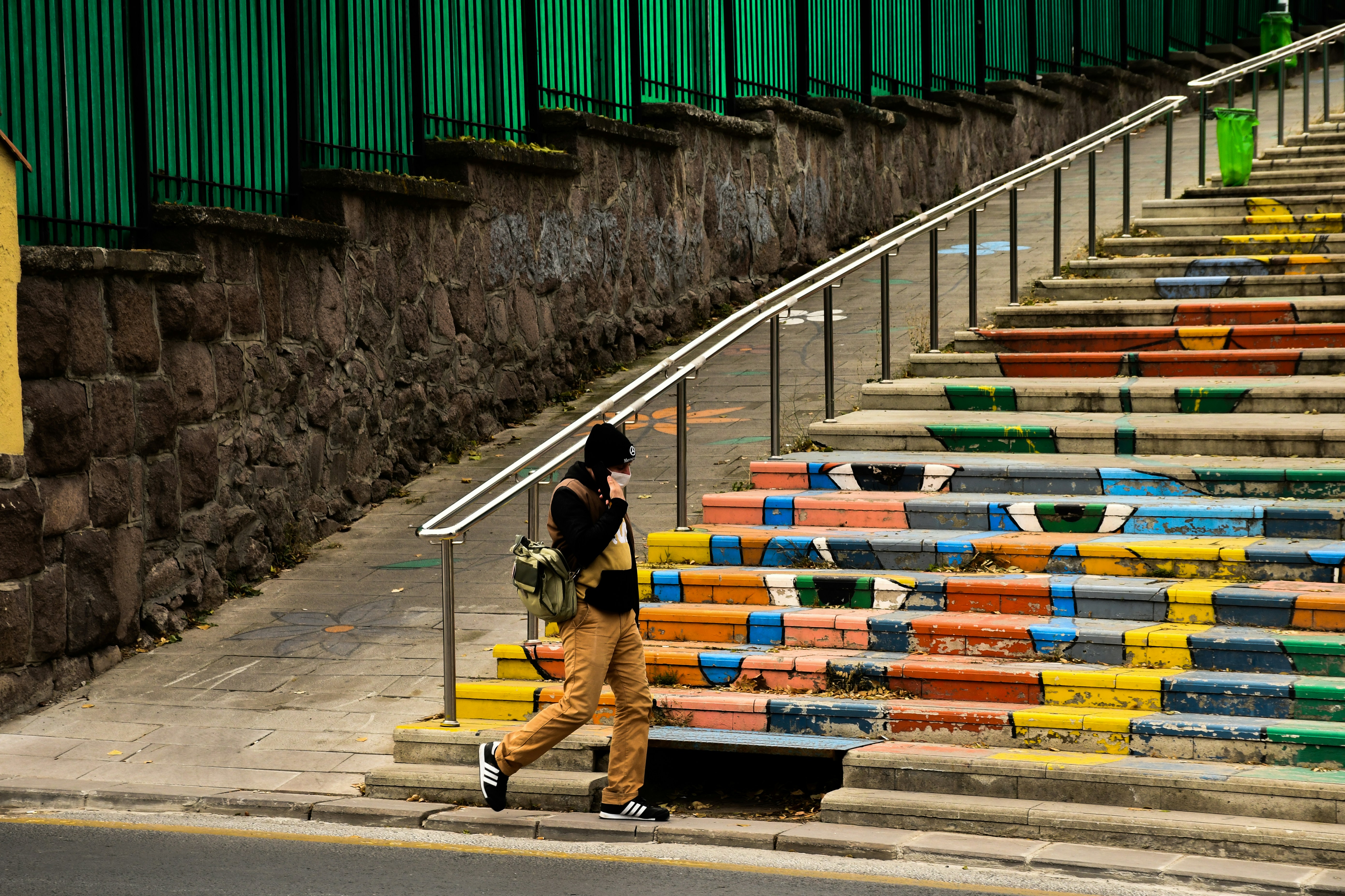 Colorful Steps and a Wanderer: A Quiet Moment on the City Staircase