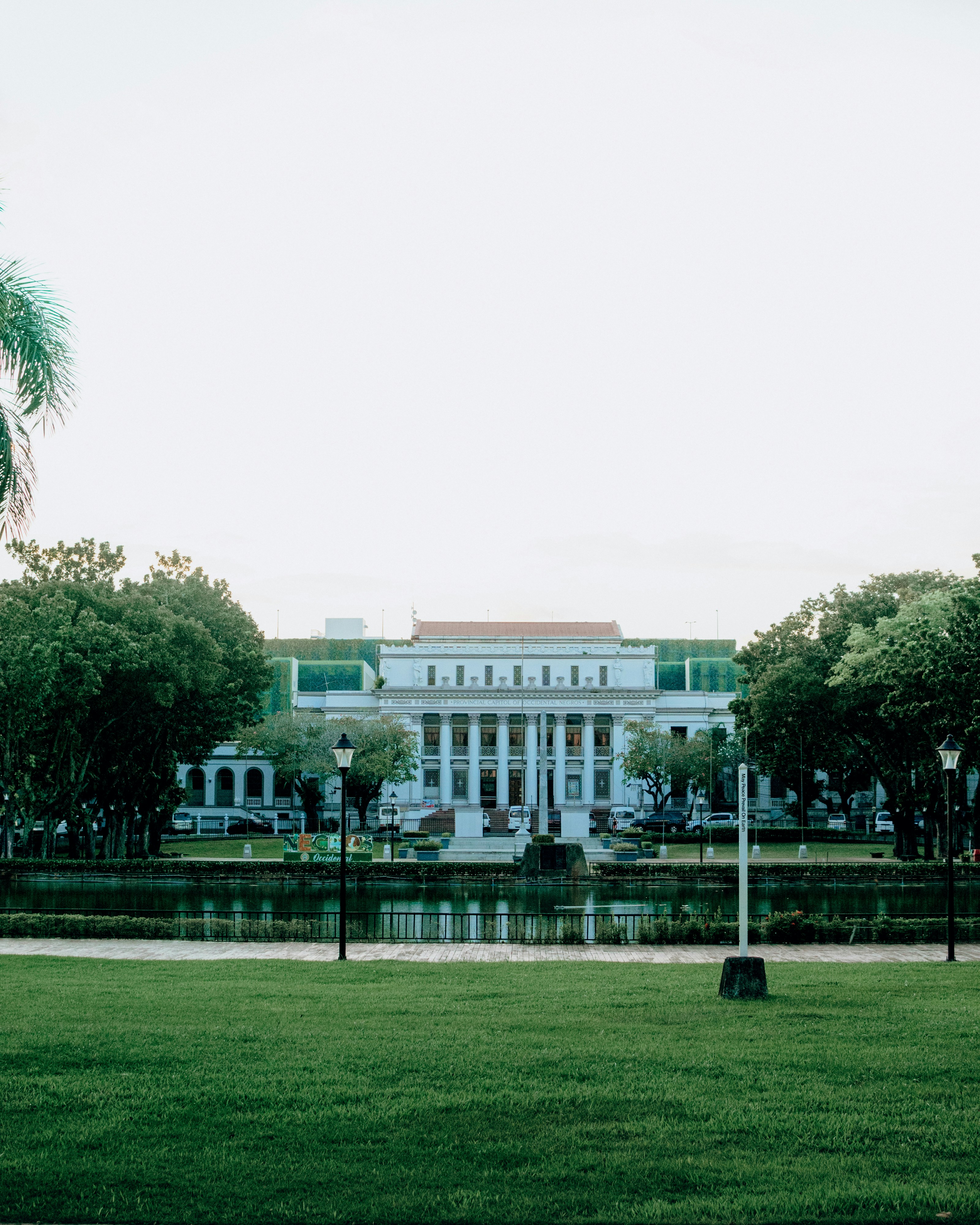 Symmetry Across the Lagoon: Neoclassical Facade Framed by Park Green