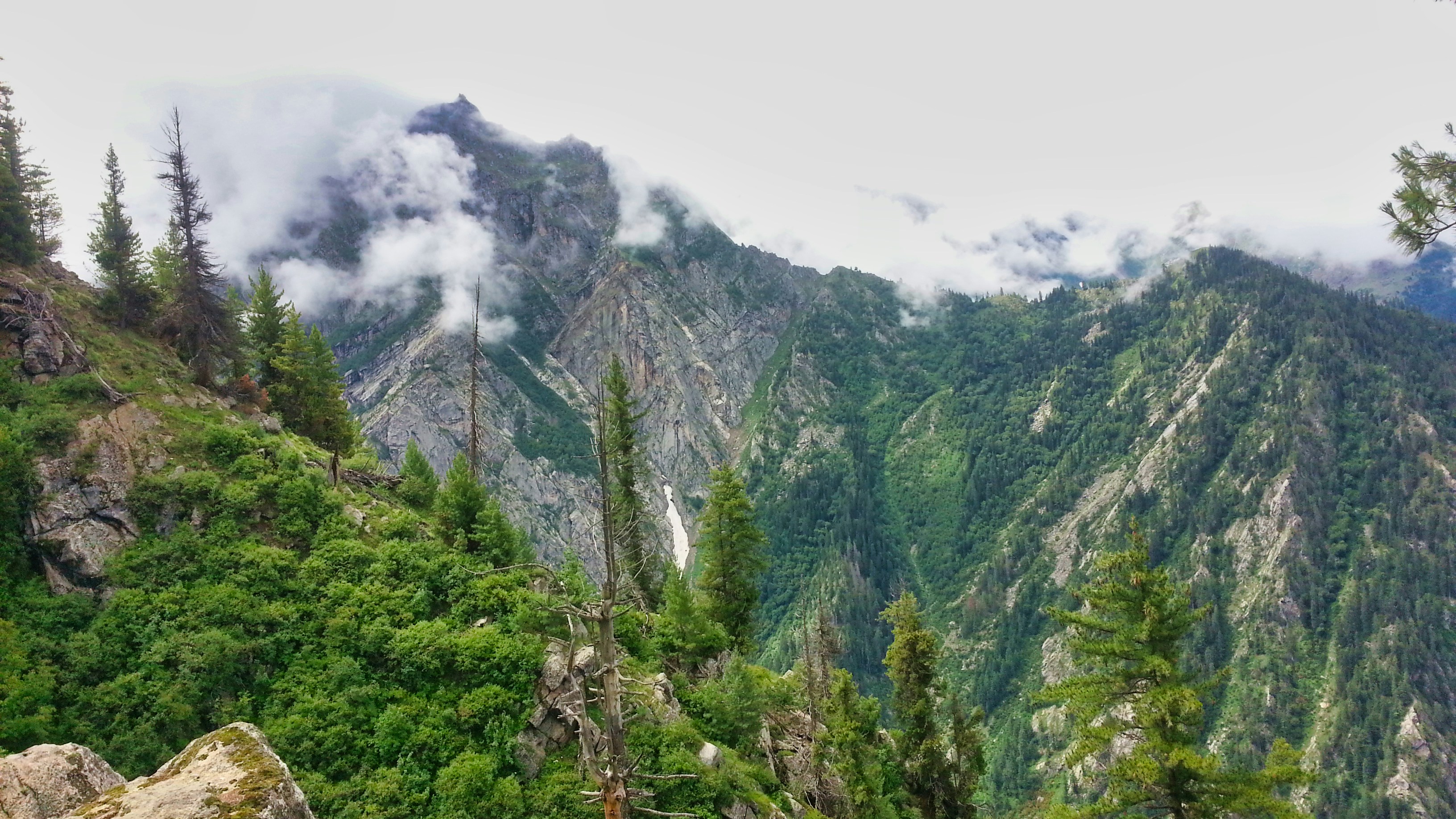 Cloud-kissed mountains and lush green valleys in Kinnaur, Himachal Pradesh.