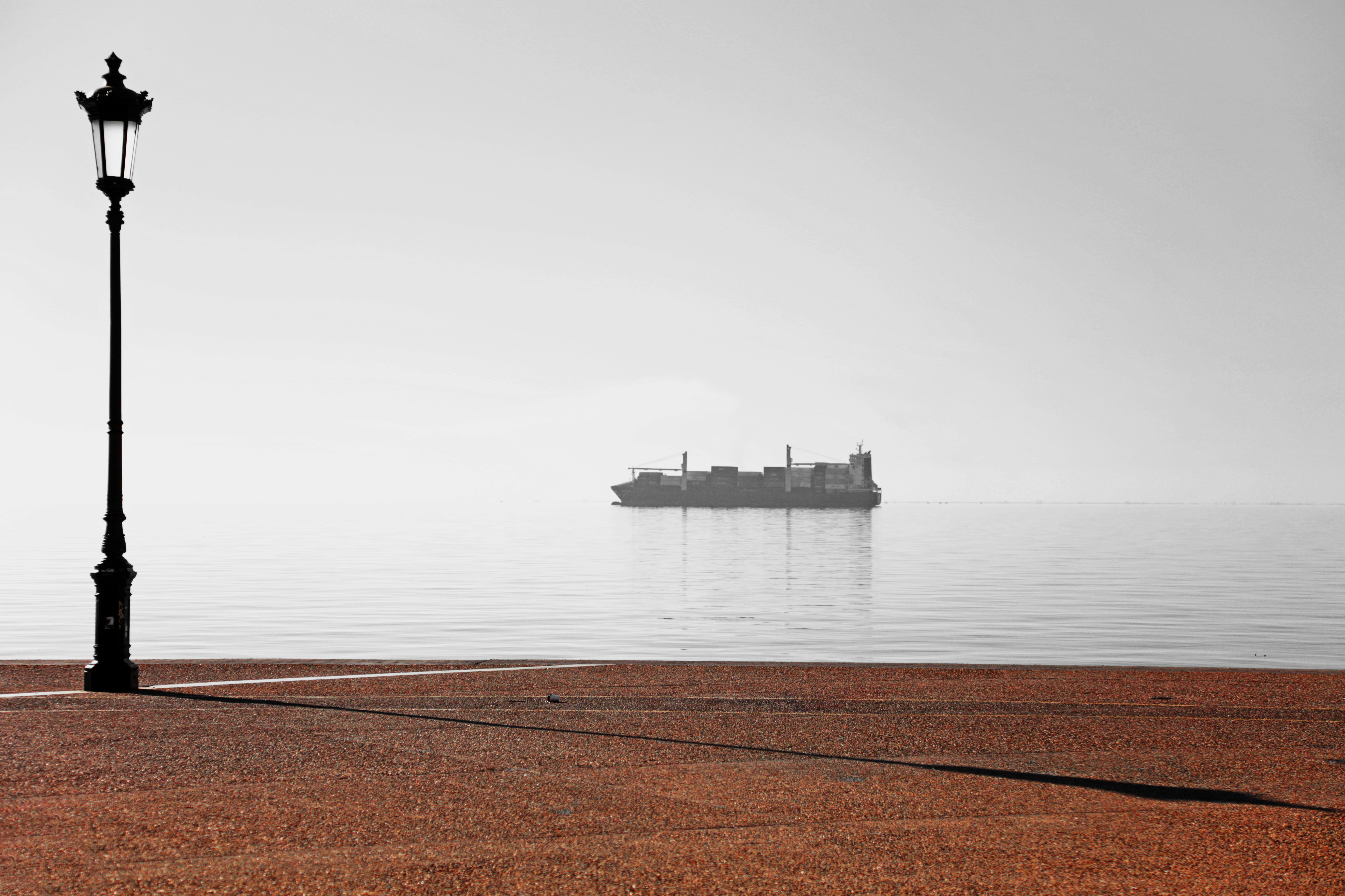 Silhouette Serenity: Ship on a Misty Horizon