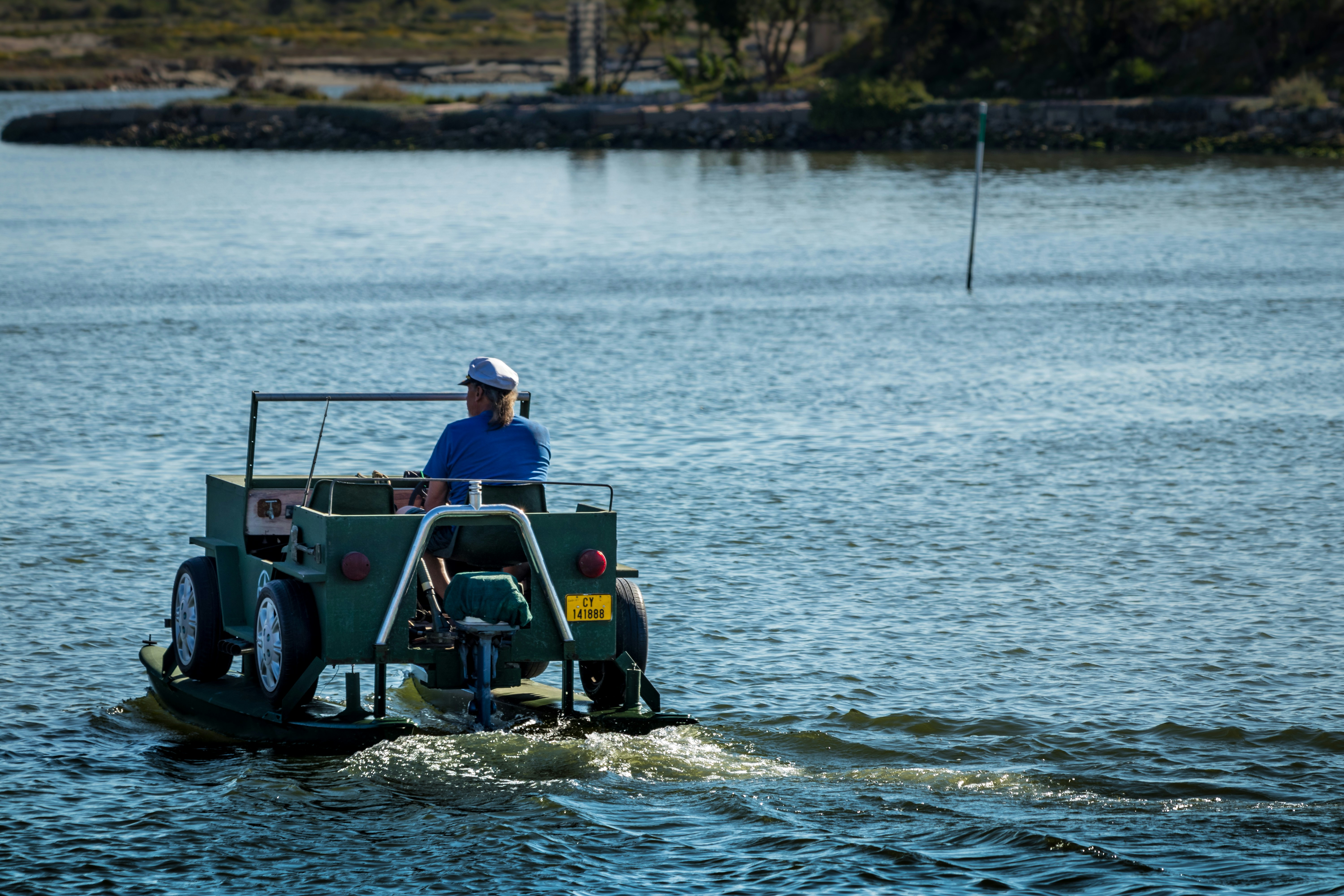 Crew In a Green Utility Boat Navigating Calm Waters