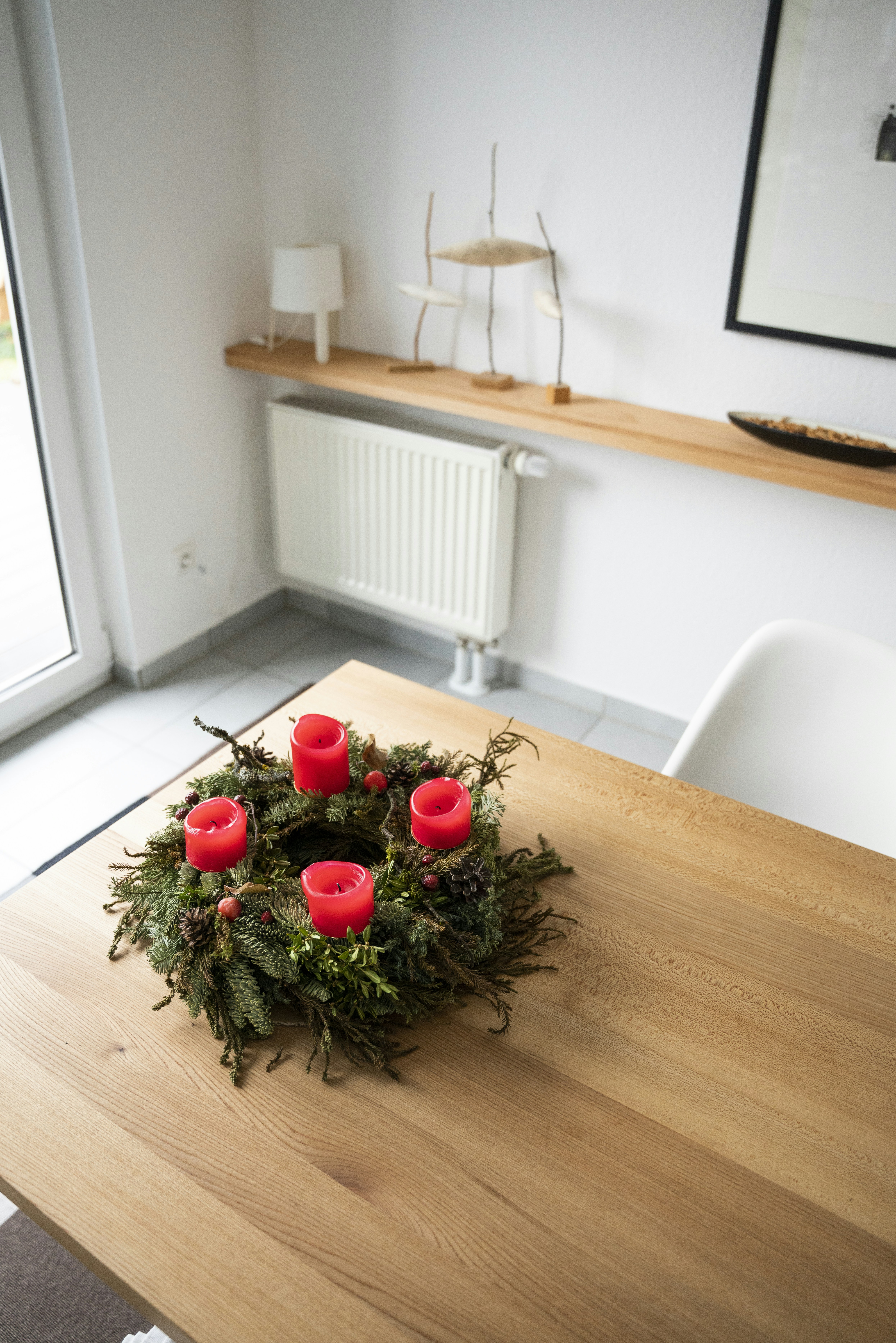 Candlelit Advent Table centerpiece in a bright minimalist dining nook