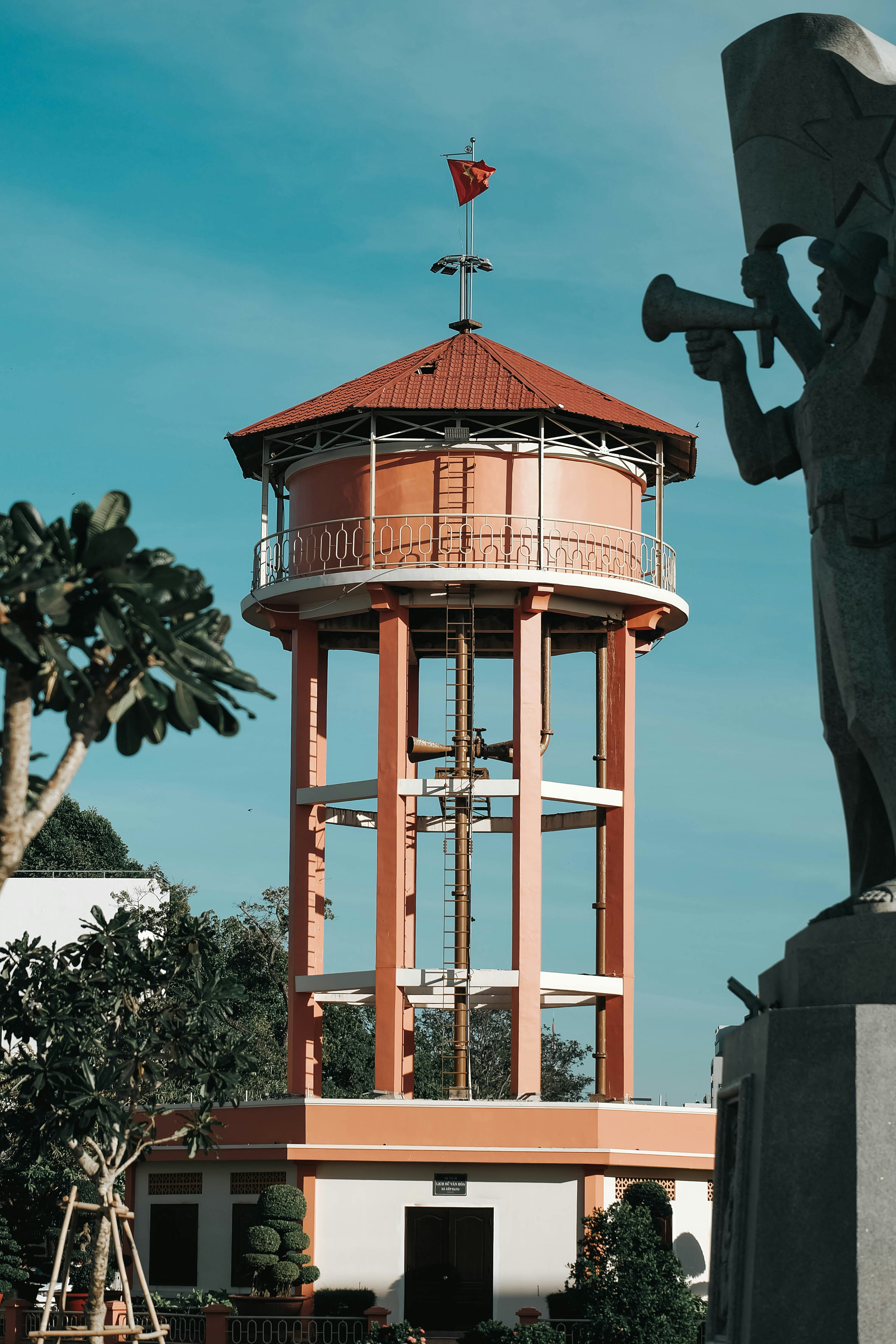 Circular Watchtower Rising Above a Red Tile Roof