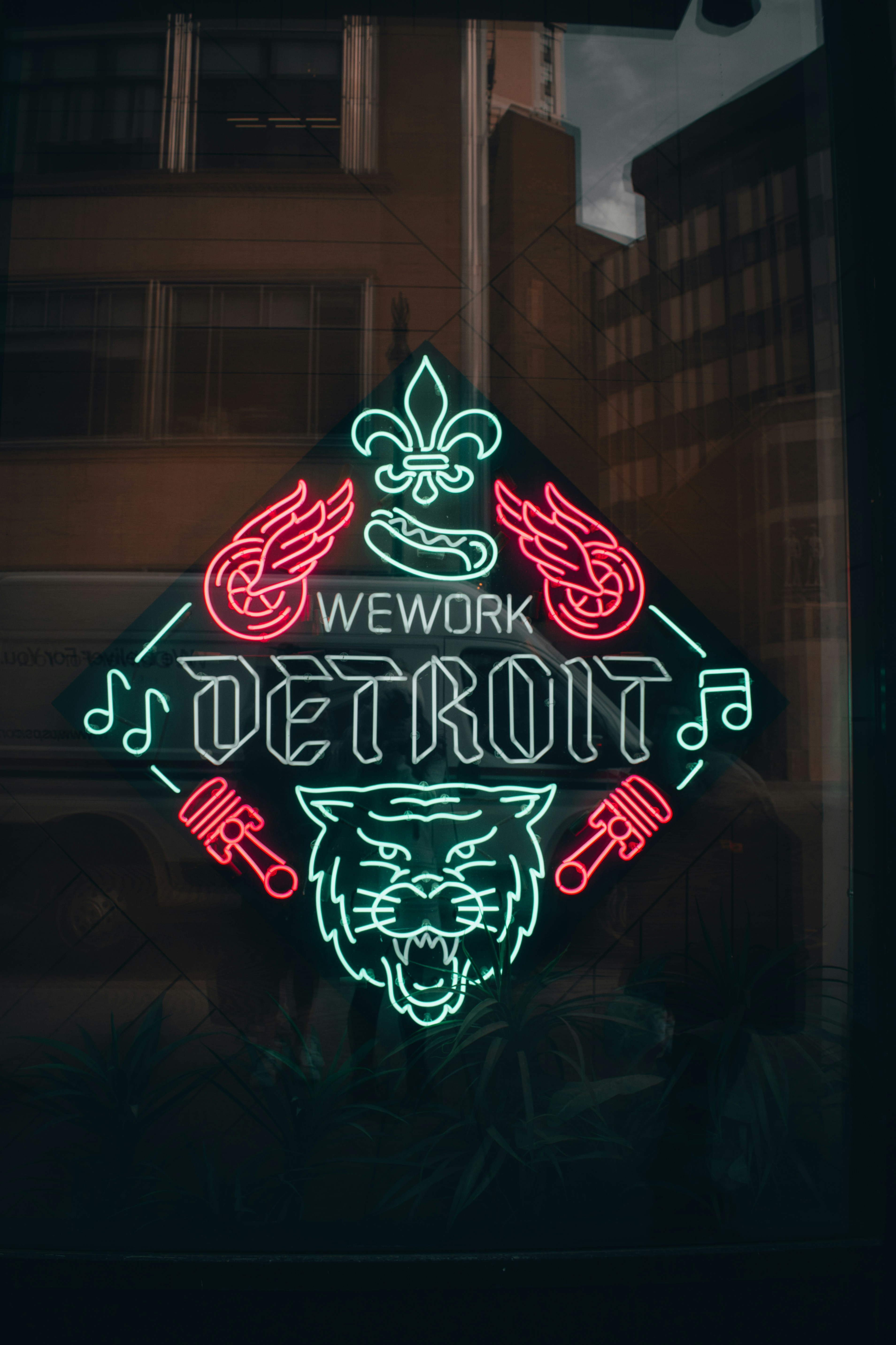 A neon sign that says we work detroit photo – Free Street photography ...