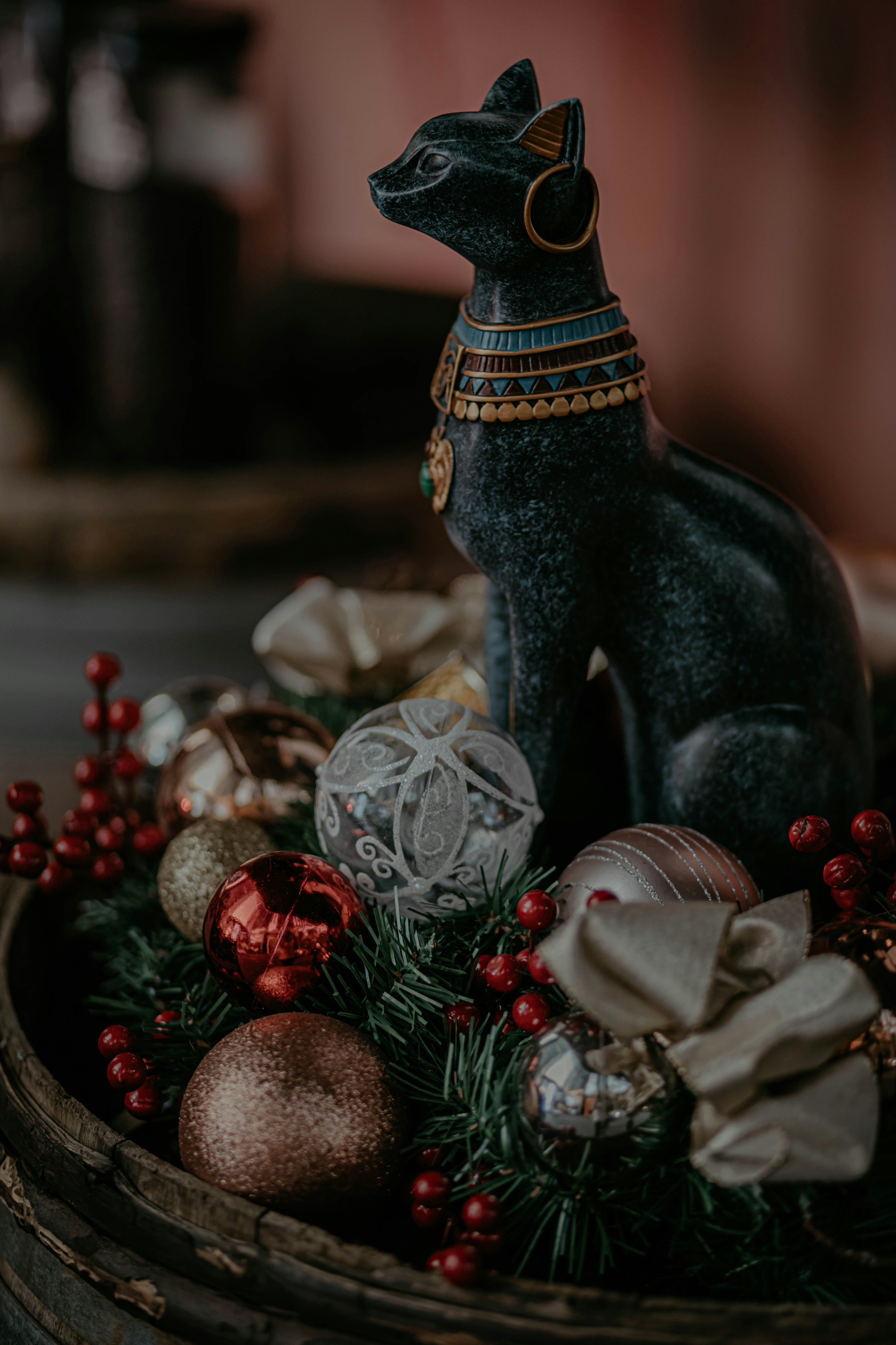 Regal Cat Effigy: Velvet Noir Amid Holiday Ornaments