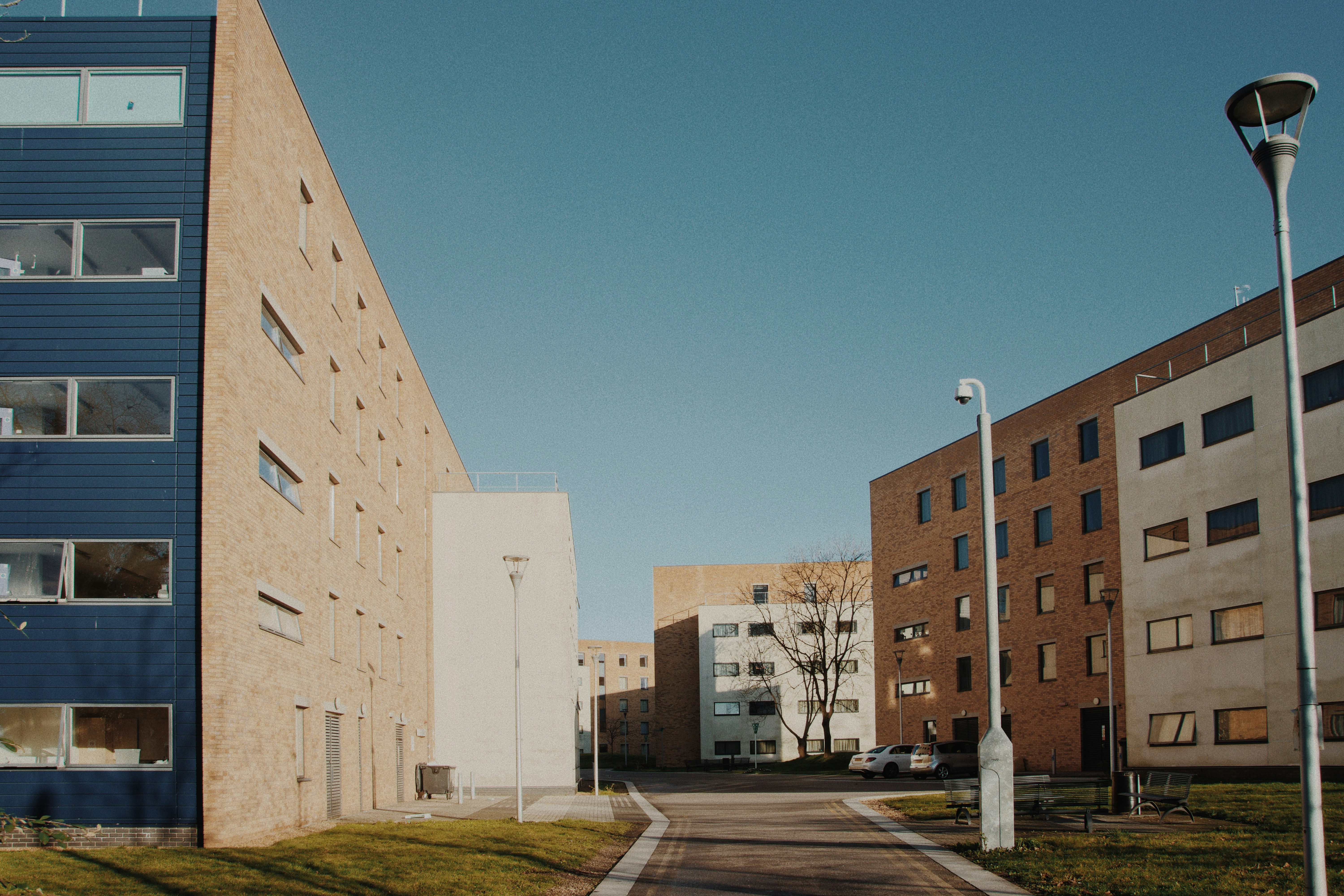 White concrete building near green grass field during daytime photo ...