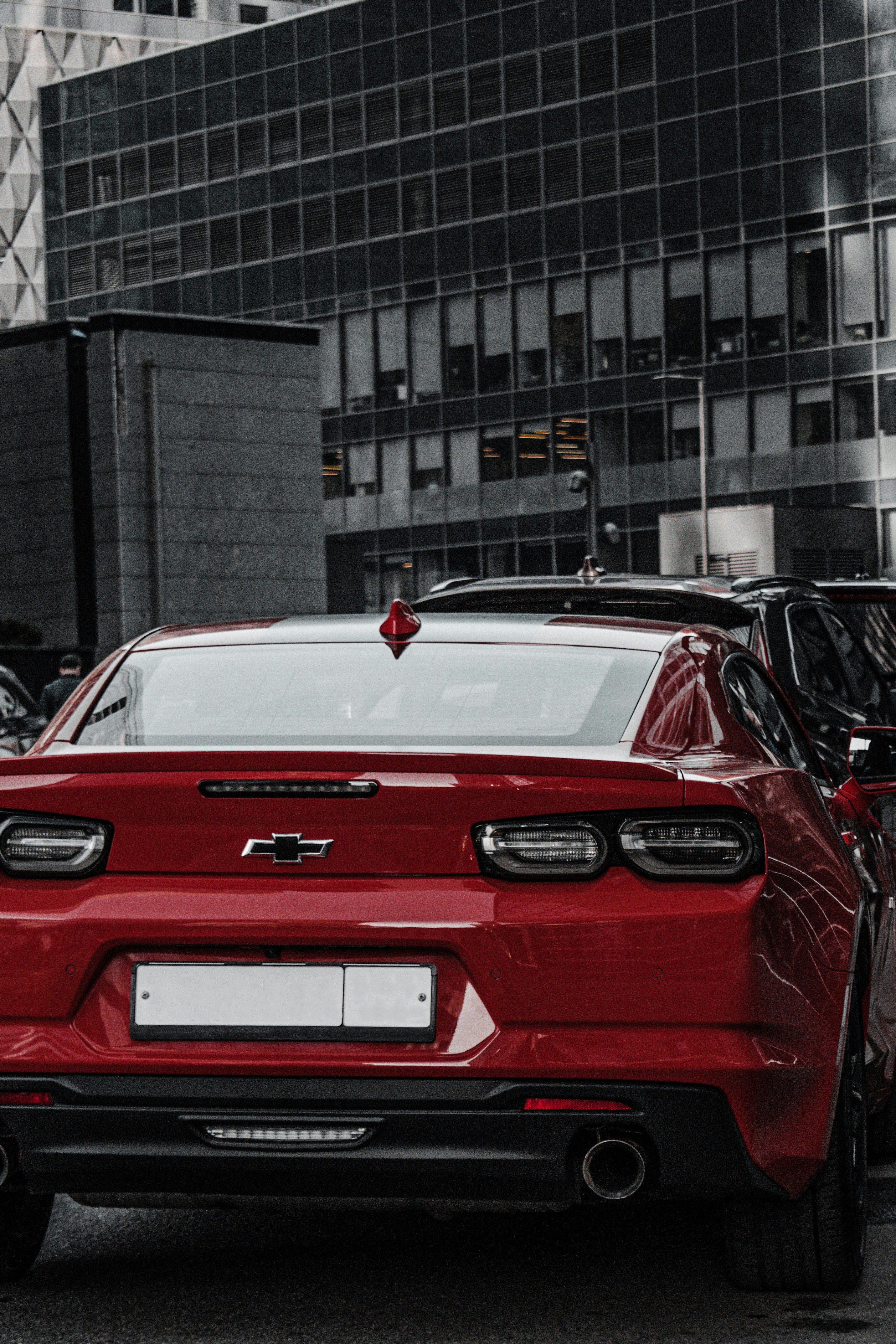 Red Chevrolet in Urban Backdrop: A Bold Finish