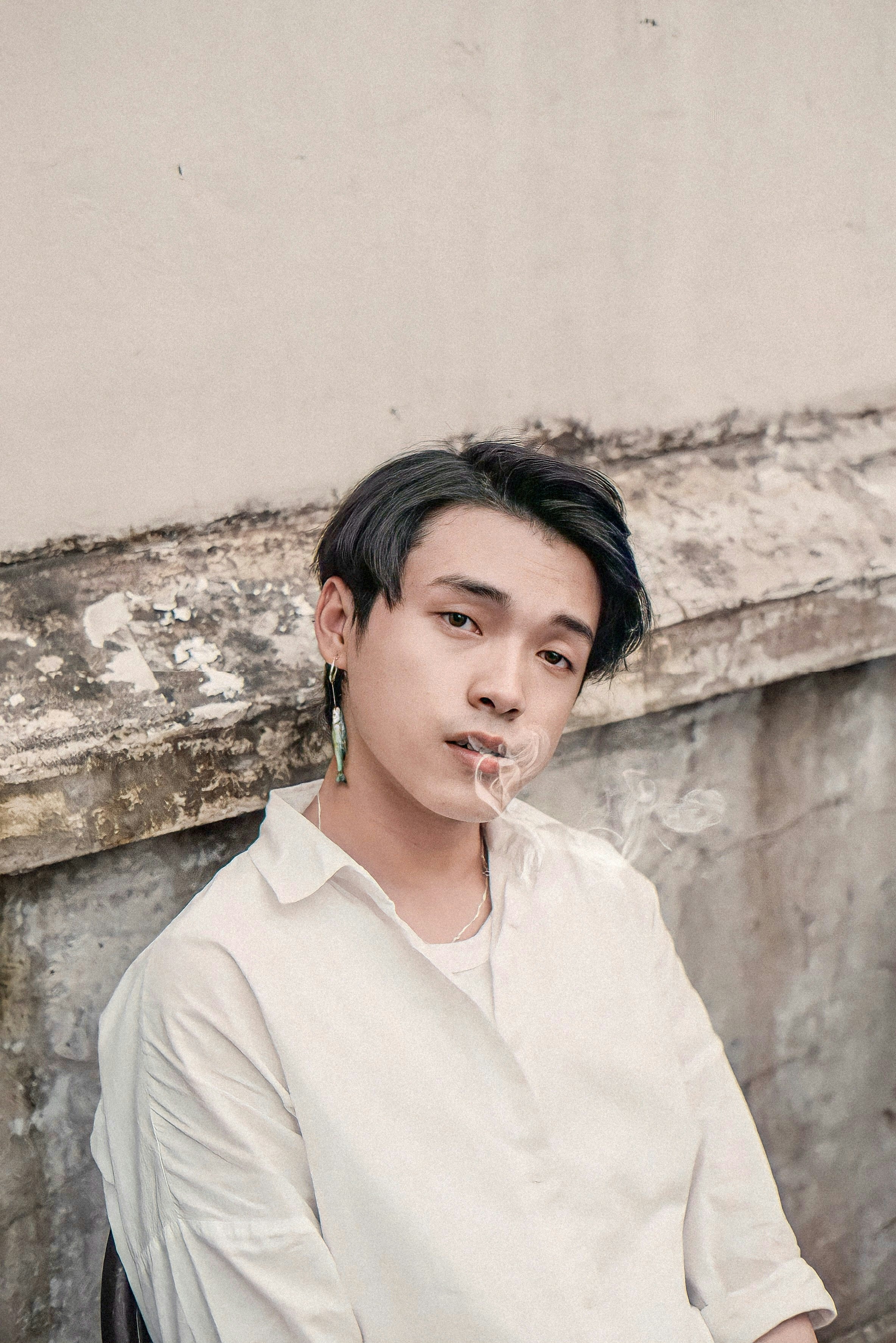 Muted Light, Quiet Confidence: Portrait Against Weathered Concrete
