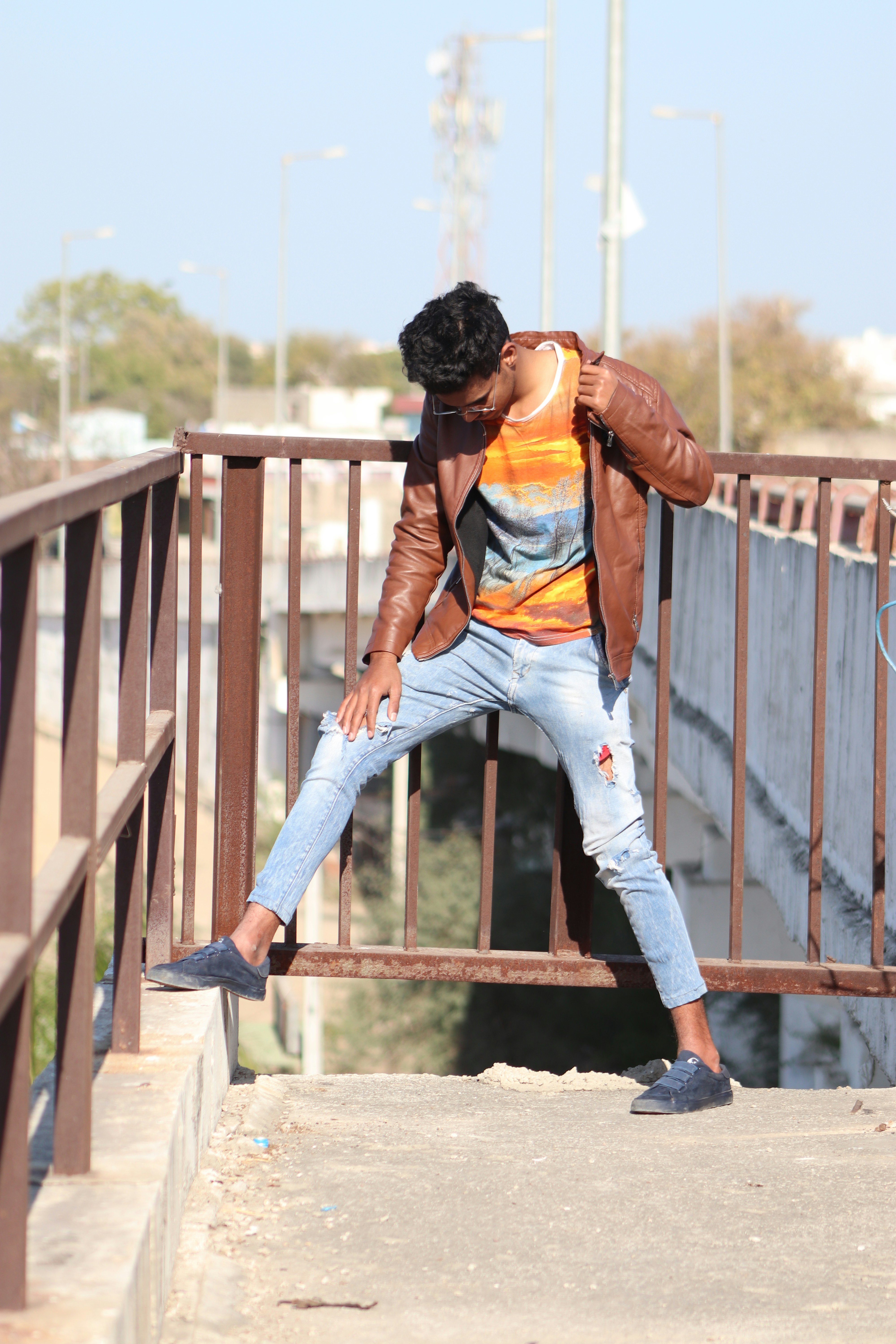 Stride Over Rails: Portrait on a Sunlit Urban Bridge
