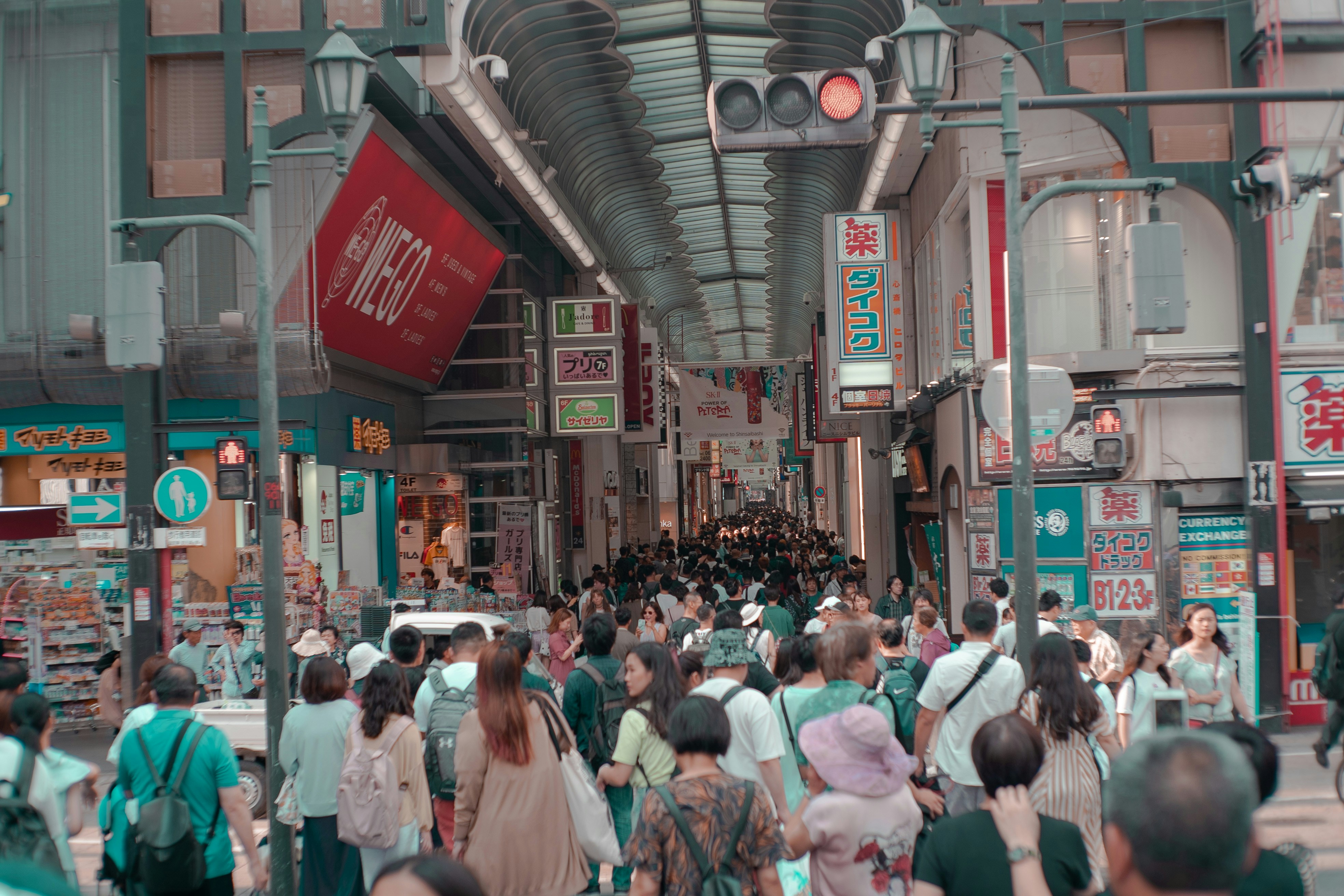 City Pulse: Crowd Navigates a Shaded Arcade in a Busy Market Street