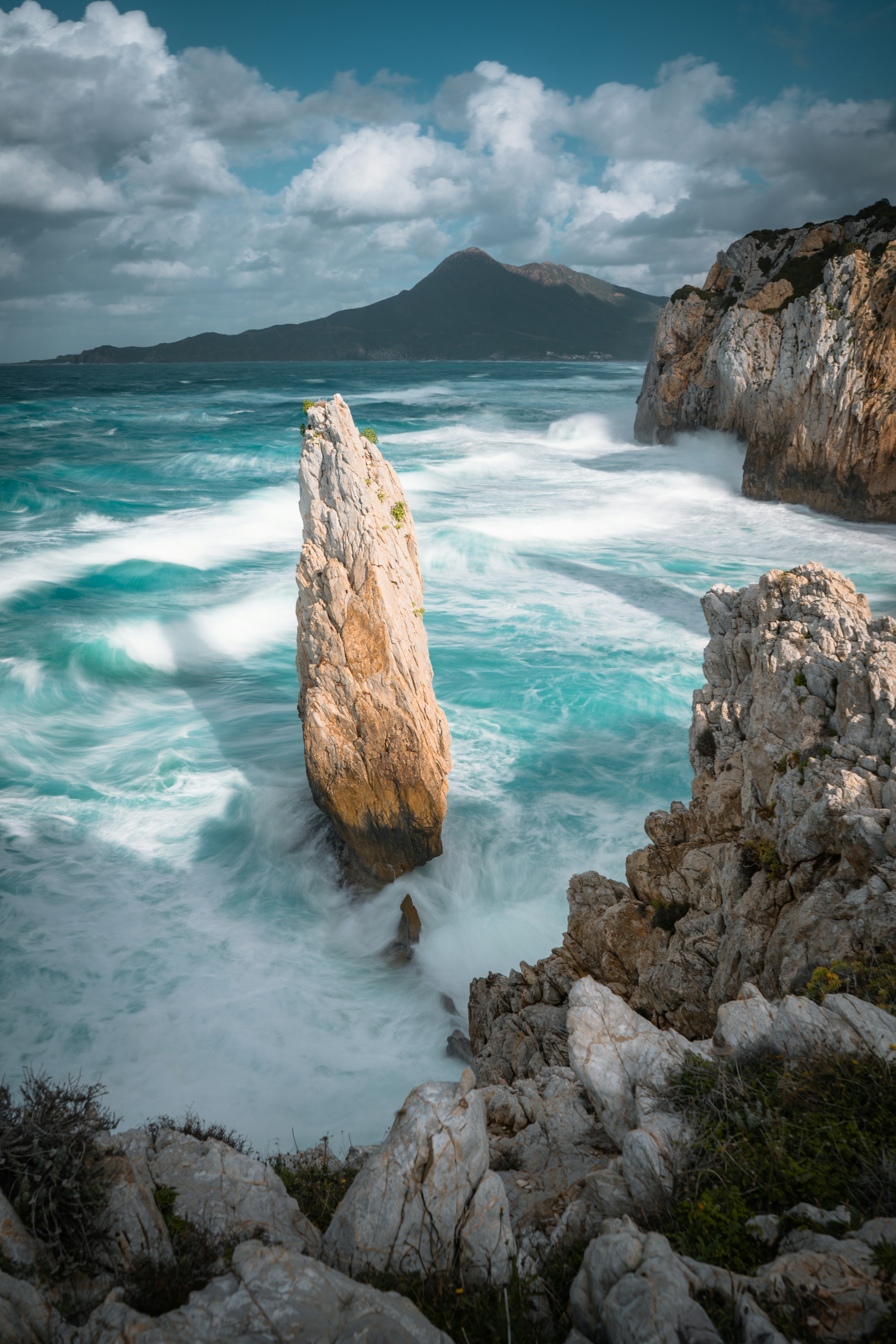 Sea Stencil: A solitary sea spire rising from turquoise surf
