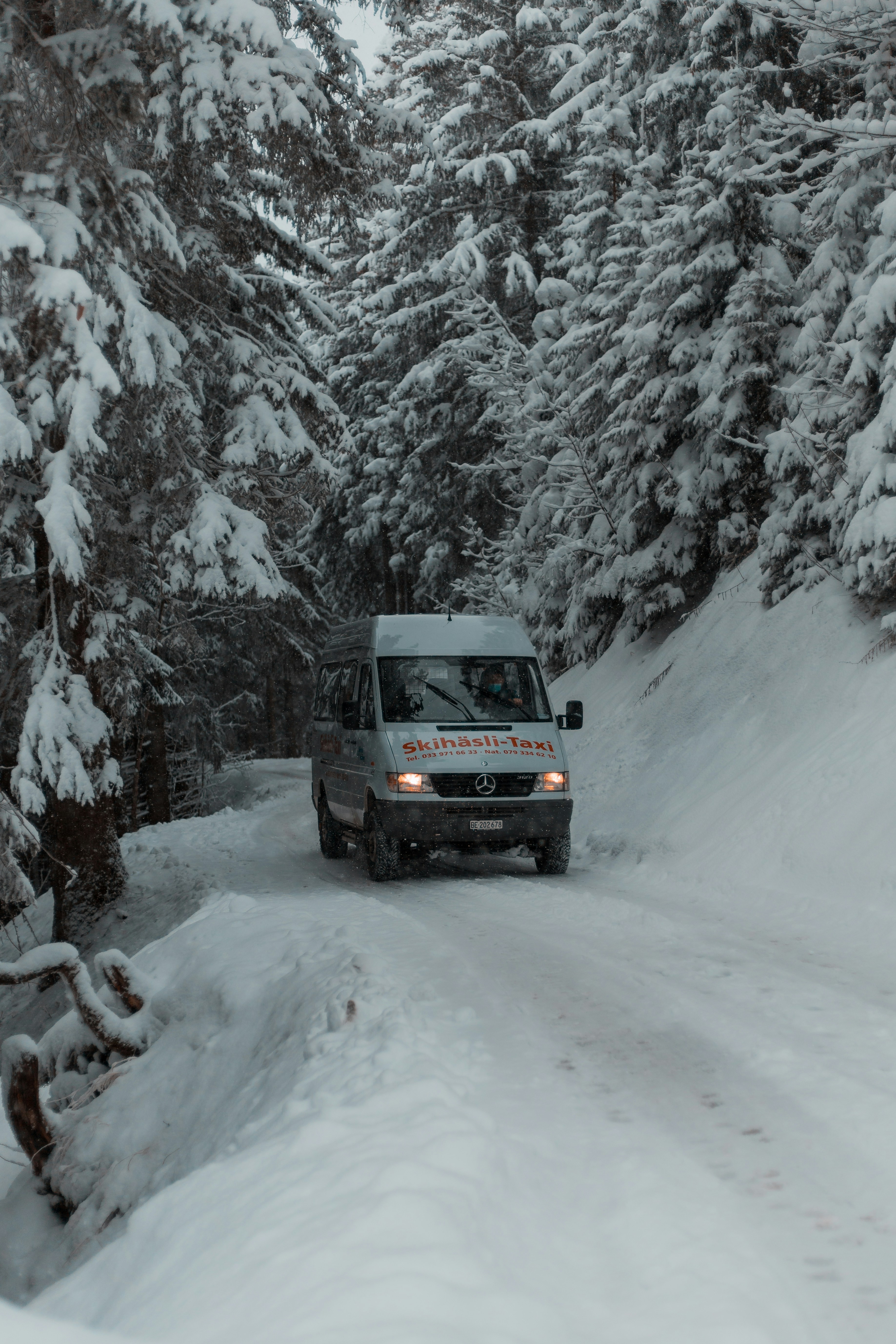 Snowbound Transit: A Mercedes van Navigates a Velvet Canyon