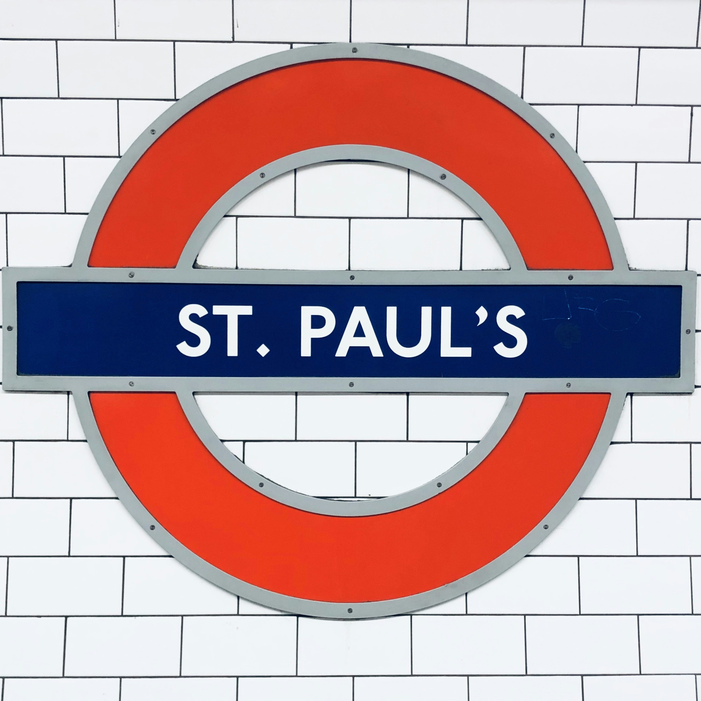 Stairway to the Underground: St. Paul’s Sign Framed by White Tiles