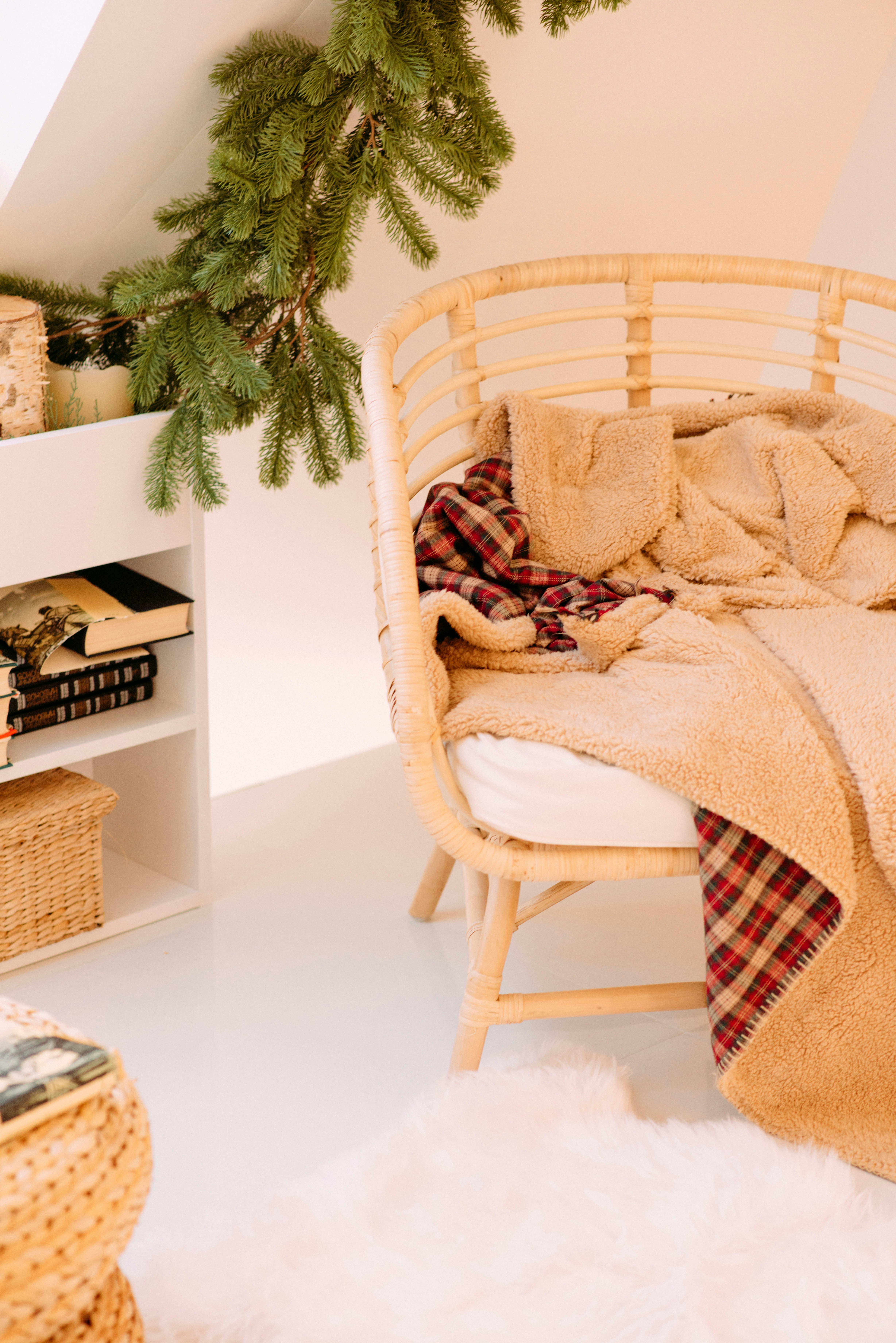 Cozy Corner: Plush Throws and Woven Chair in Sunlit Nook