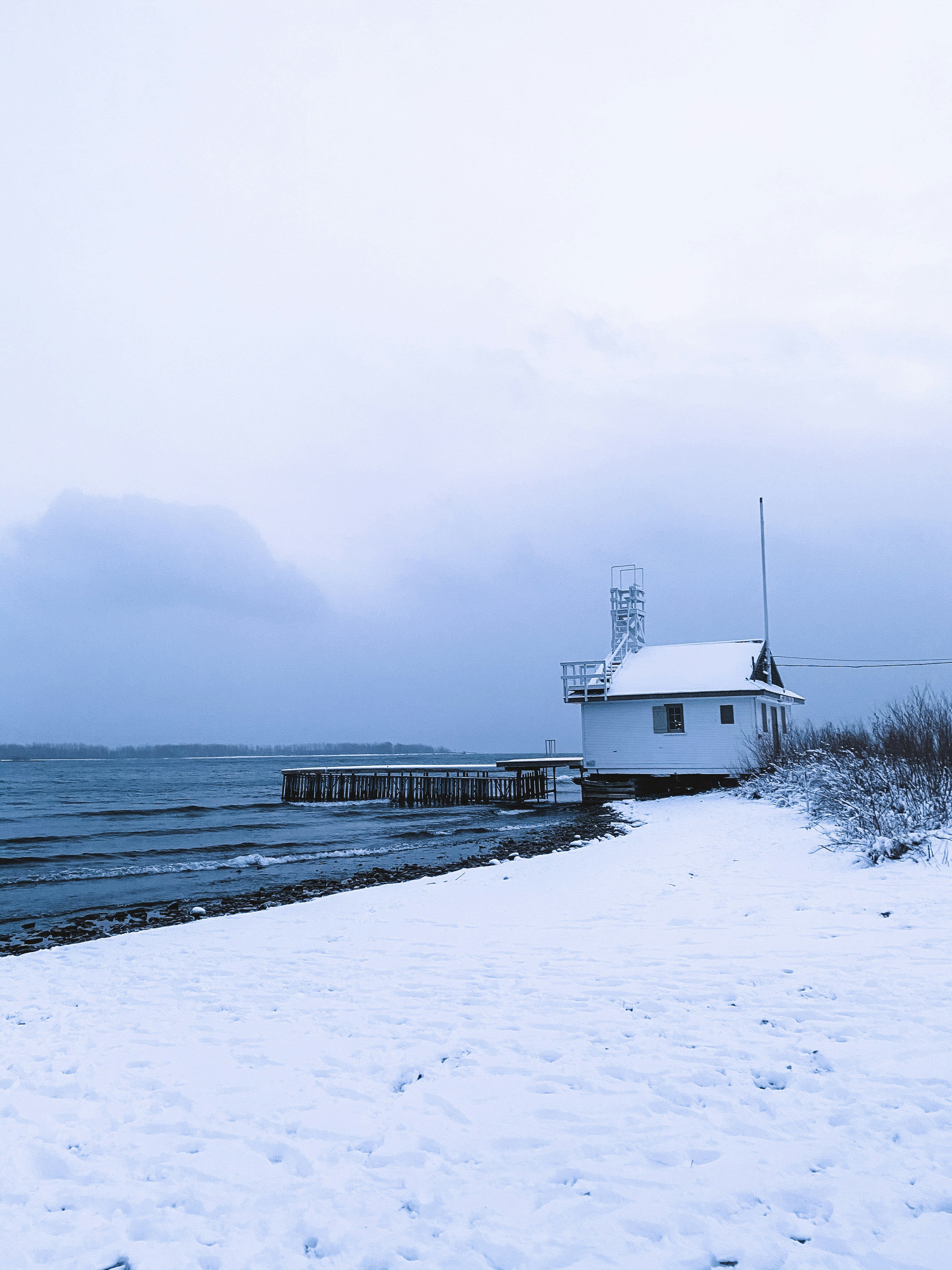 Snowbound Pier House: Quiet Winter Seascape by the Shore