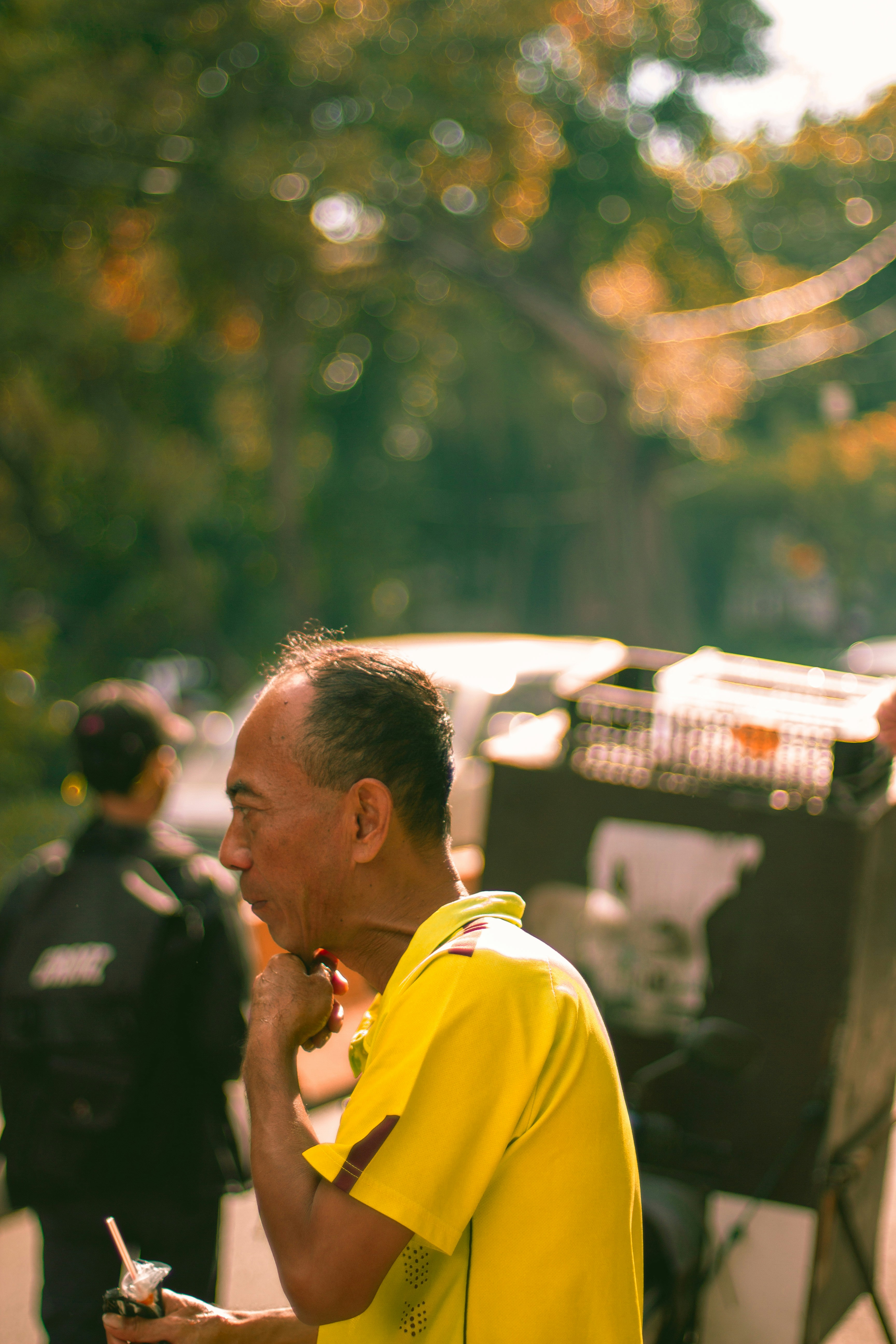 man in yellow polo shirt standing near man in black shirt