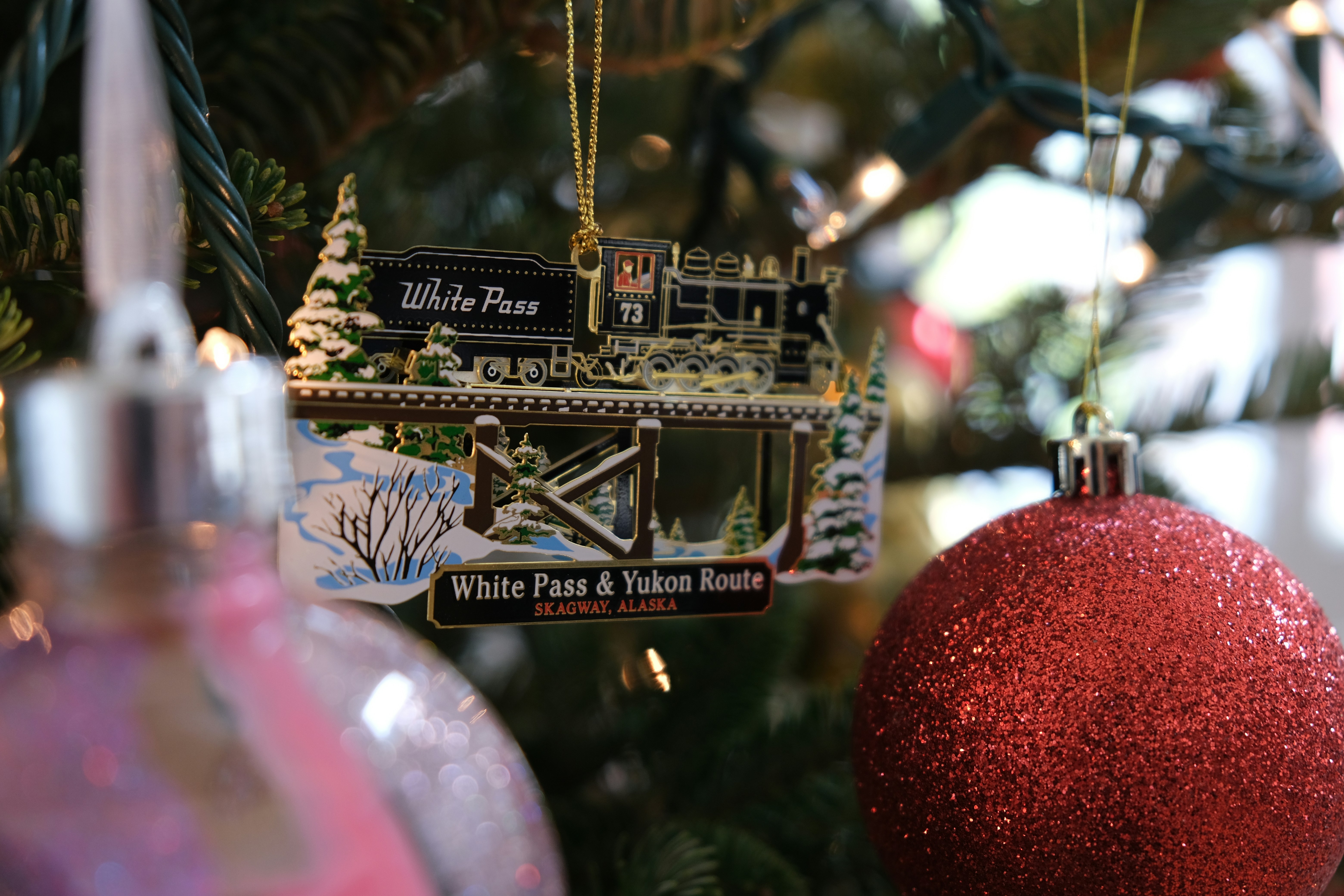 Miniature White Pass & Yukon Route Train Ornament Dangles Among Christmas Tree Lights