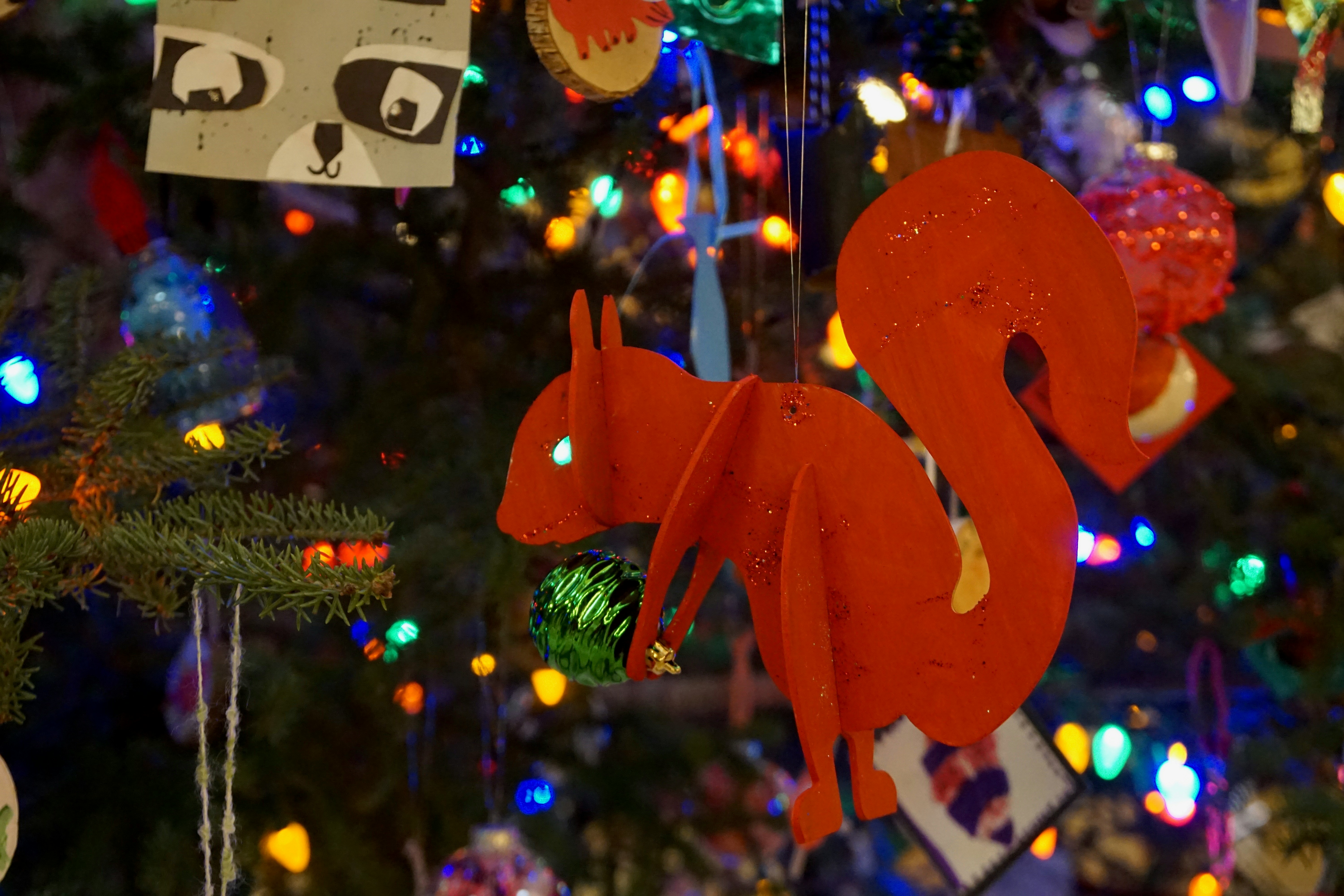 Crimson Flamingo Ornament Illuminating a Christmas Tree of Neon Lights