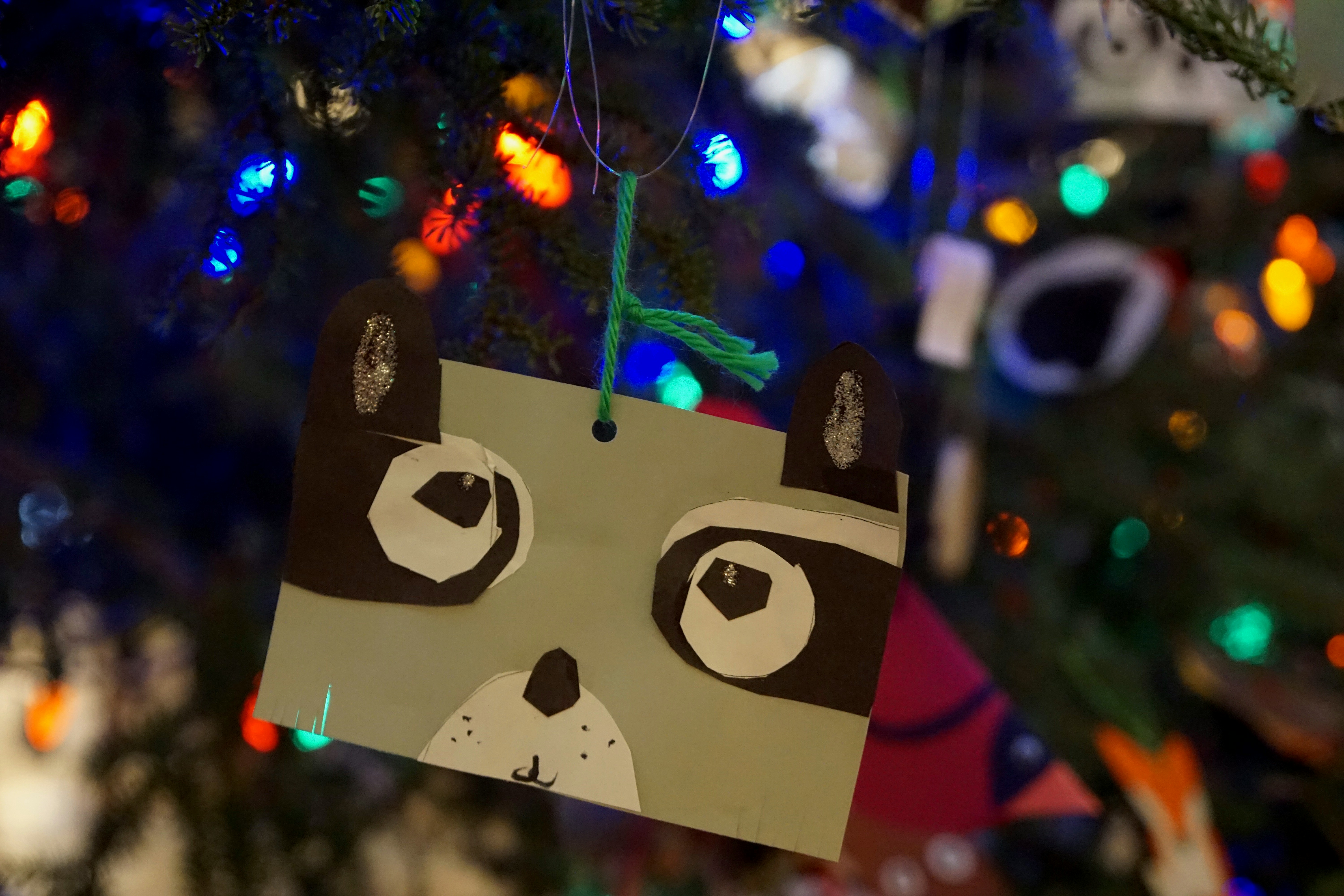 Ornament of a Panda: A Handmade Card Dangles in a Velvet Holiday Glow