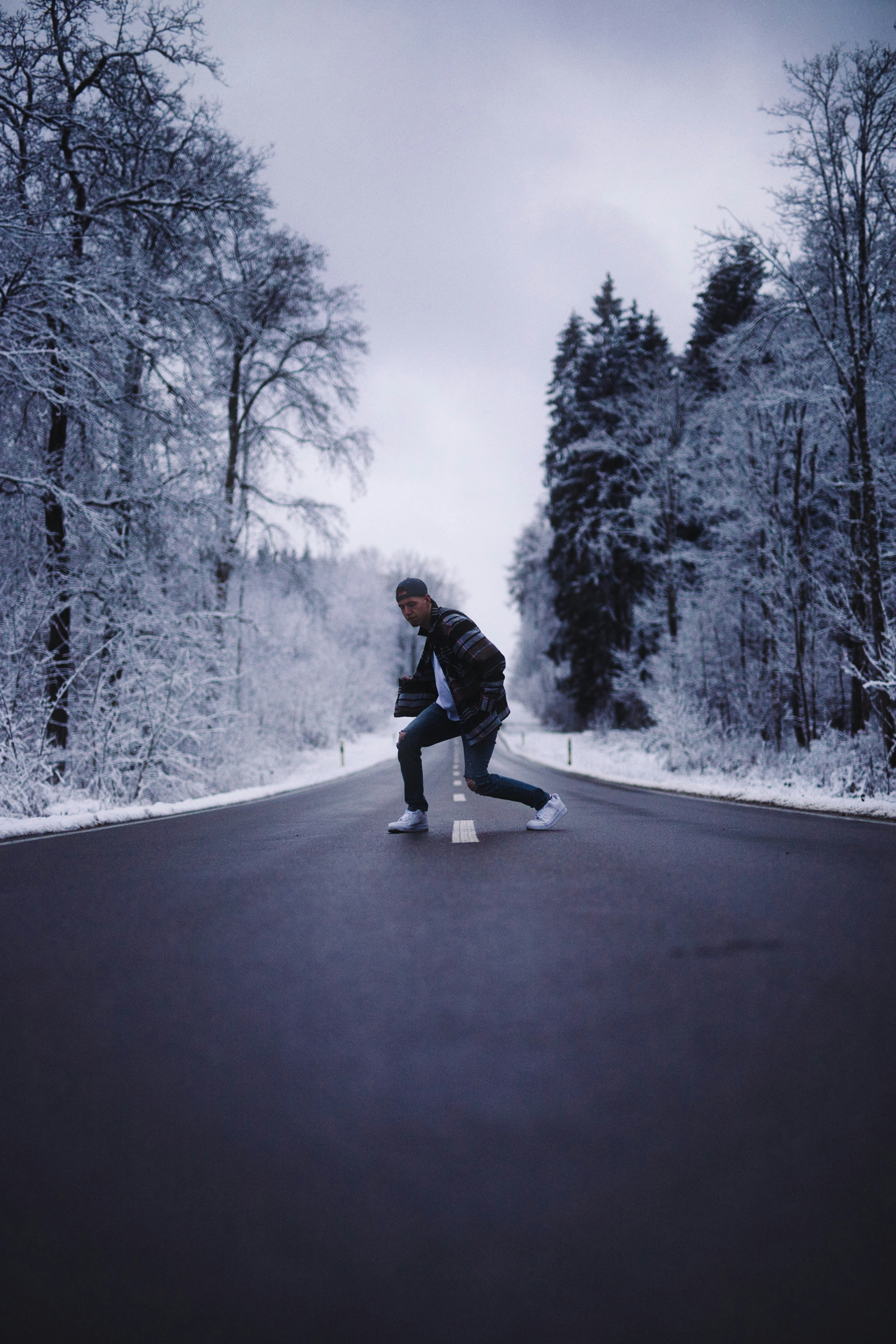 Stride in the Snow: A Runner Halt on a Quiet Winter Road